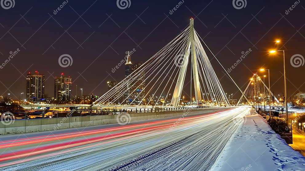 Night Cityscape with Cable-stayed Bridge, Light Trails, and Snow Stock ...
