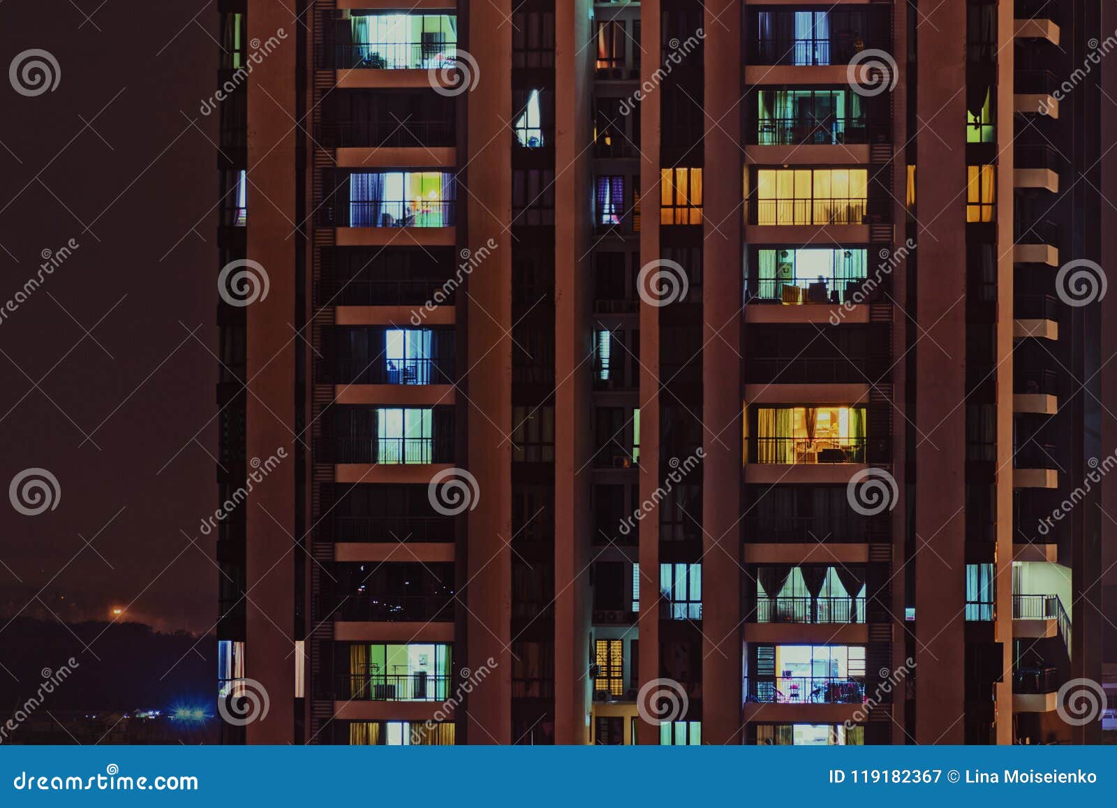 Night Front View of Modern High-rise Building with Windows of Cozy ...
