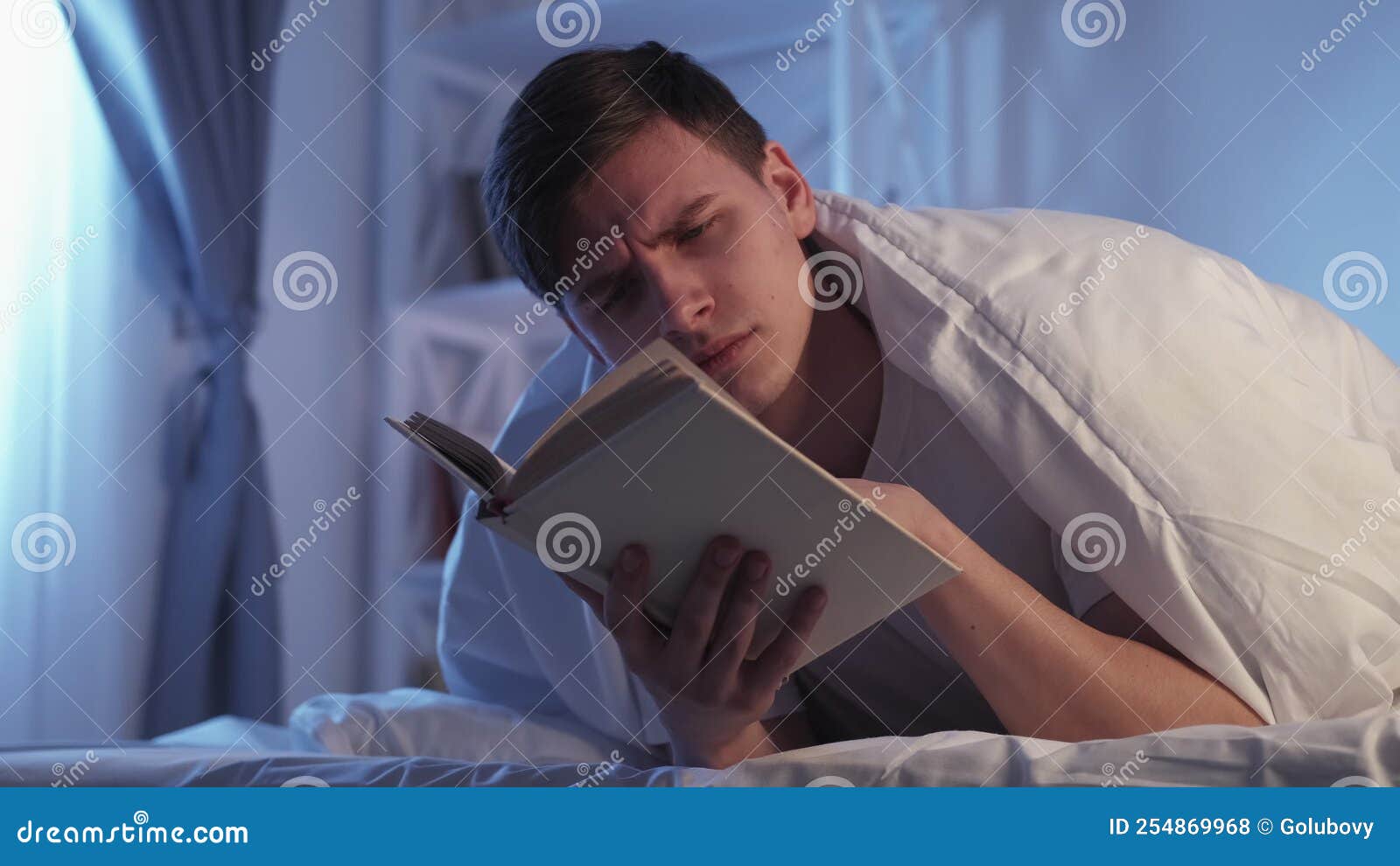 Night Reading Guy Falling Asleep with Book in Bed Stock Footage - Video ...
