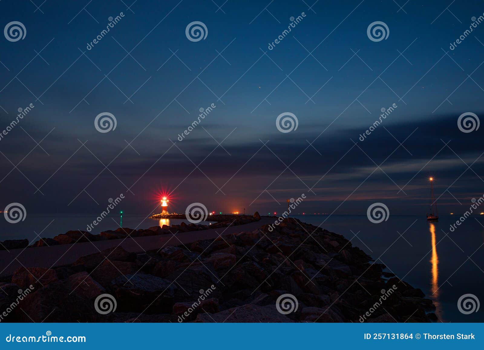 Night Scene by the Sea with a Lighthouse at the End of the Path Stock ...