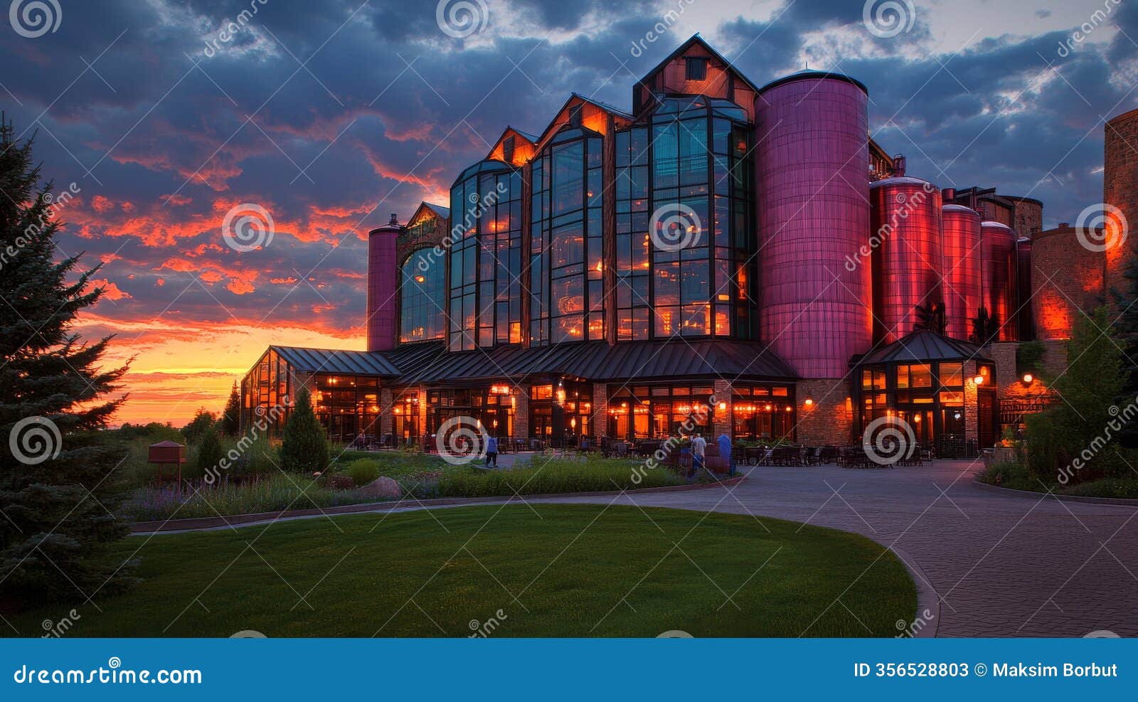 At Night, a Sizable Structure Featuring Many Glass Windows and Tanks ...