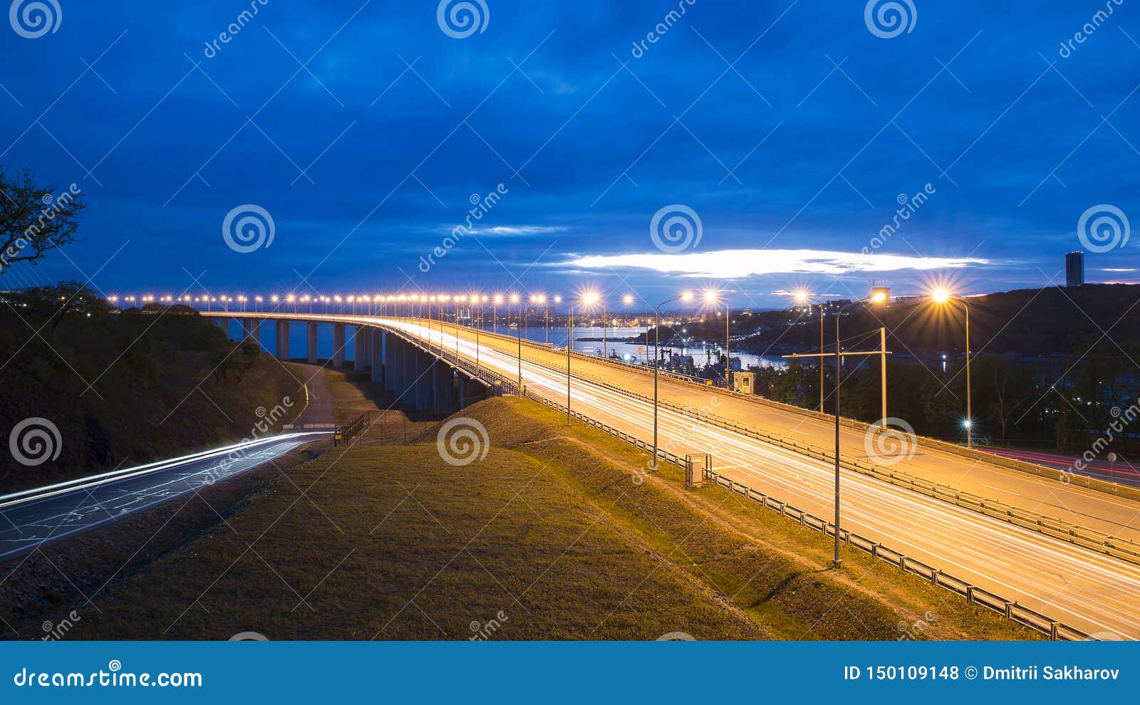 Night View of the Bridge with Traffic Lights and Cloudy Dramatic Sky ...