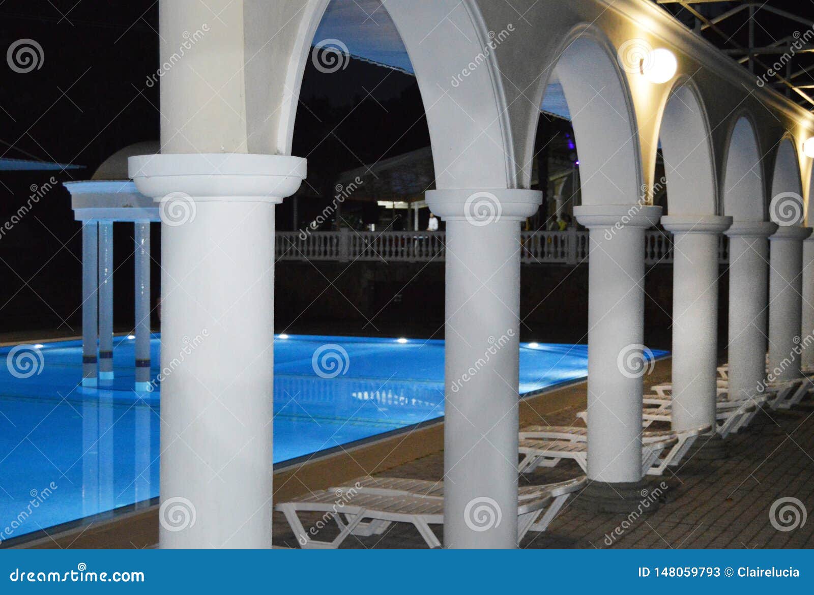 Night View of the Luxurious Pool with Columns and Arches, Reflected in ...