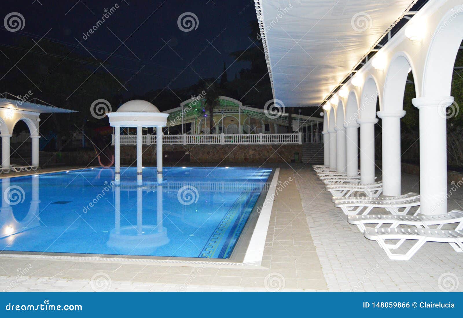 Night View of the Luxurious Pool with Columns and Arches, Reflected in ...