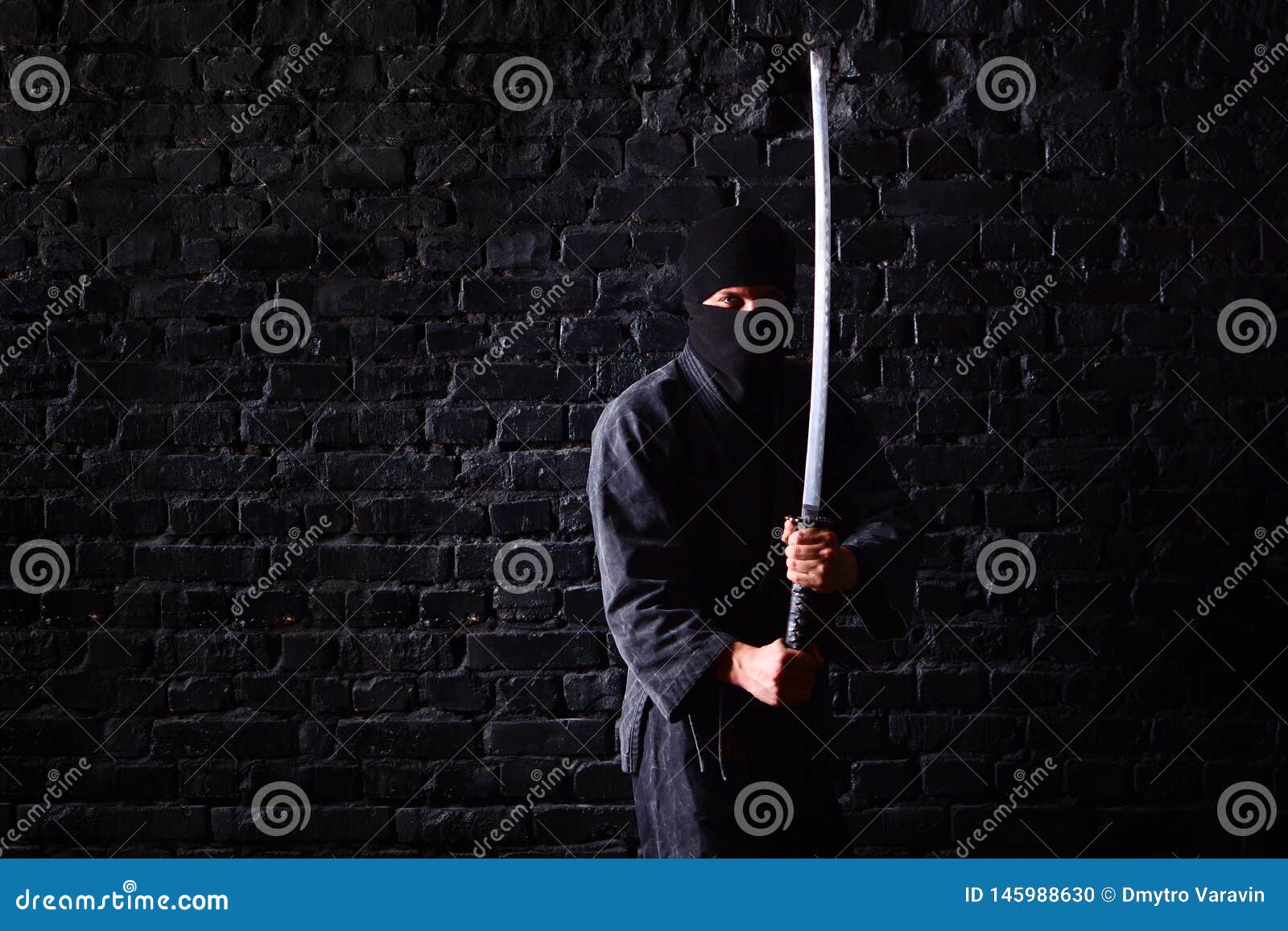 Ninja Samurai With Katana In Attack Pose On A Dark Brick Wall ...