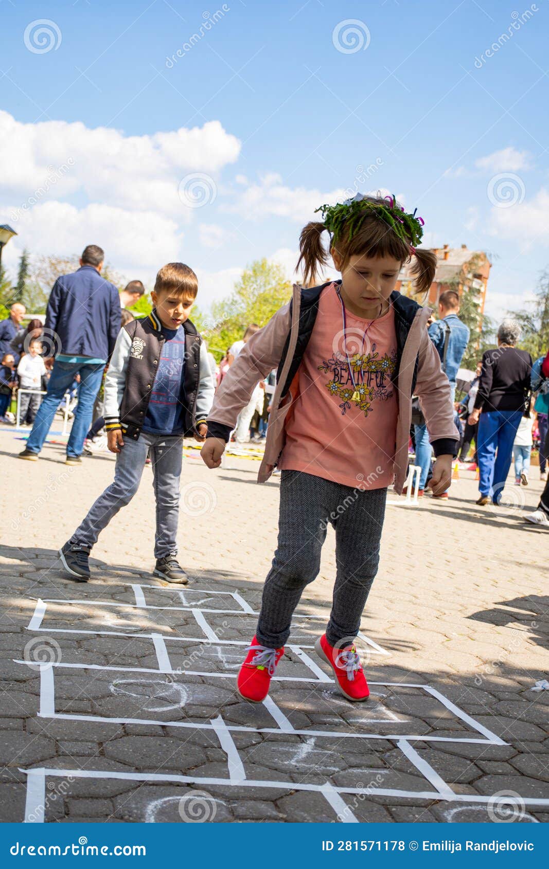 Leap into Learning: Little Girl Jumping on Chalk Marked Squares and ...