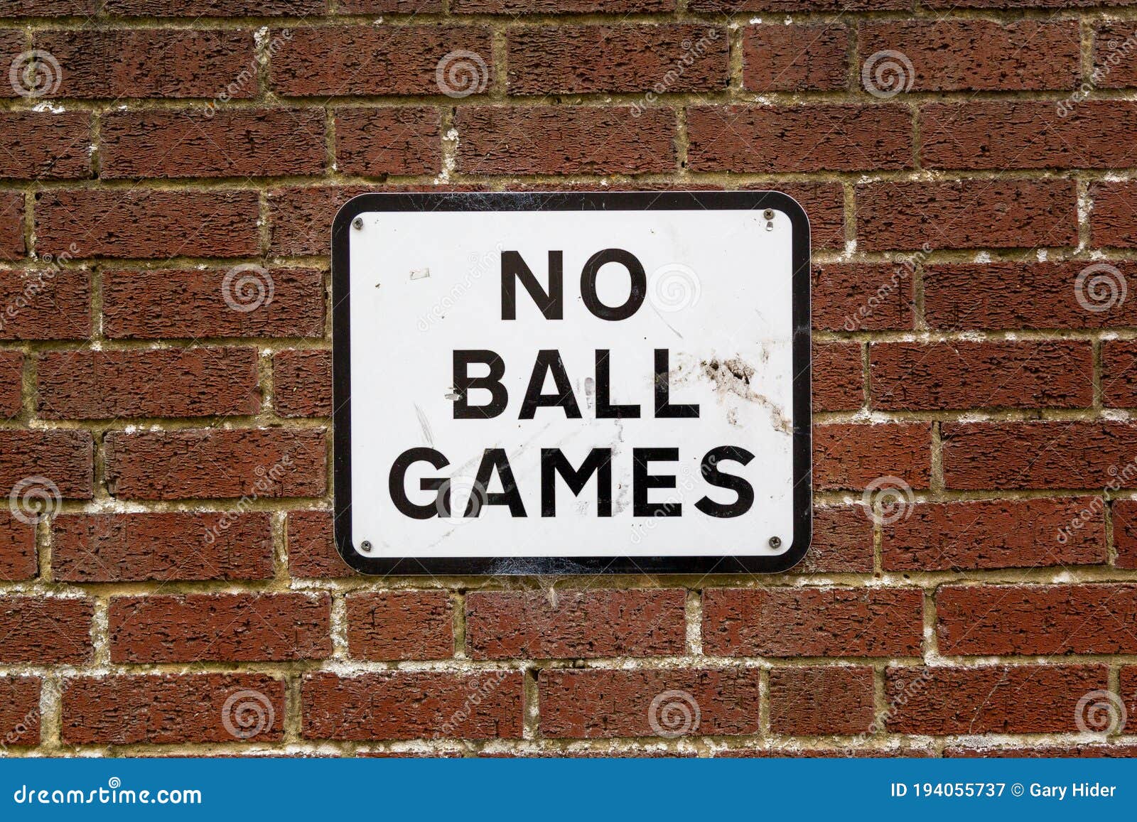 A No Ball Games Sign on a Brick Wall on the Side of a Property Stock ...