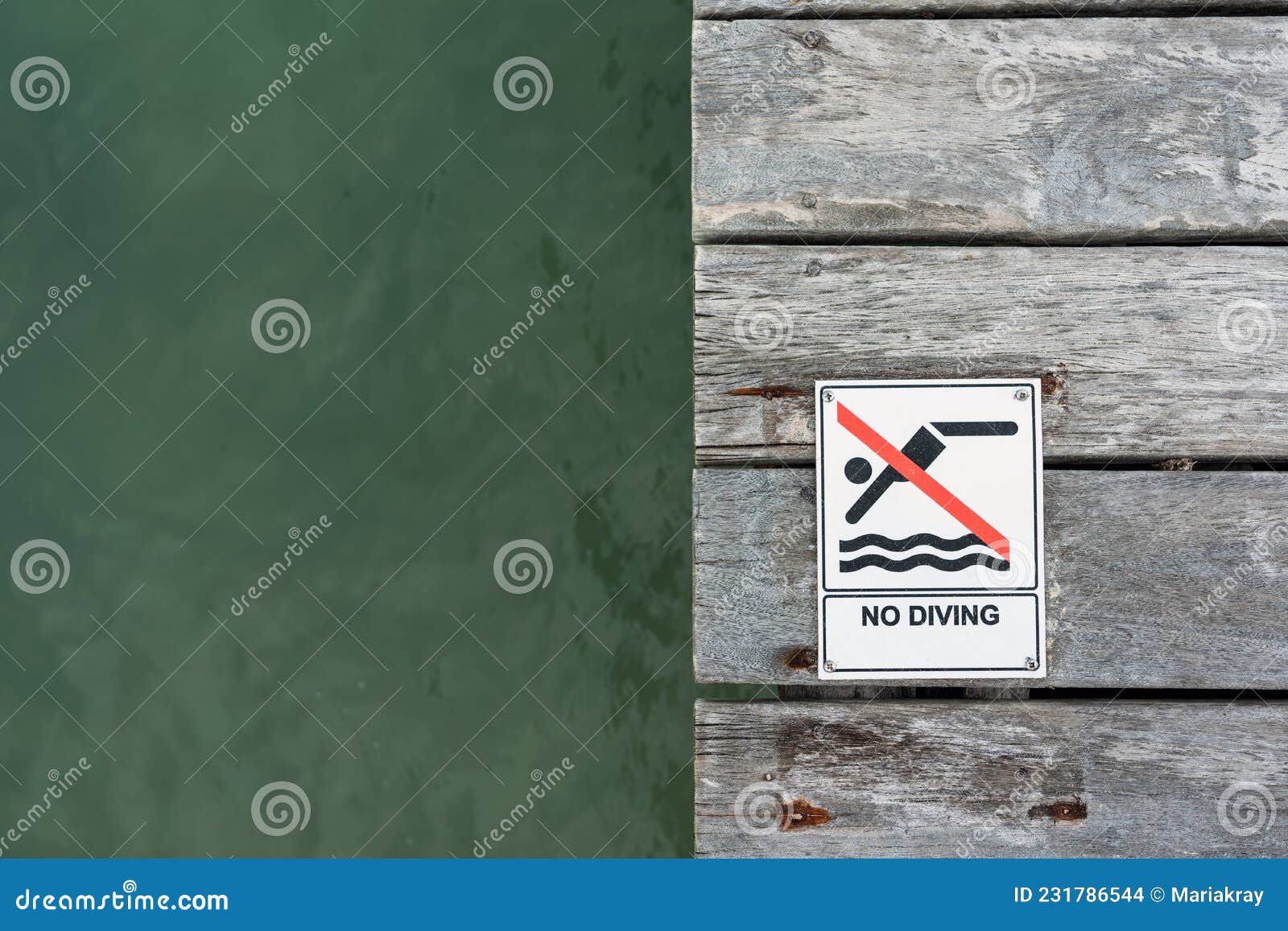 No Diving Sign on a Pier Floor with Ocean Water in the Background Stock ...