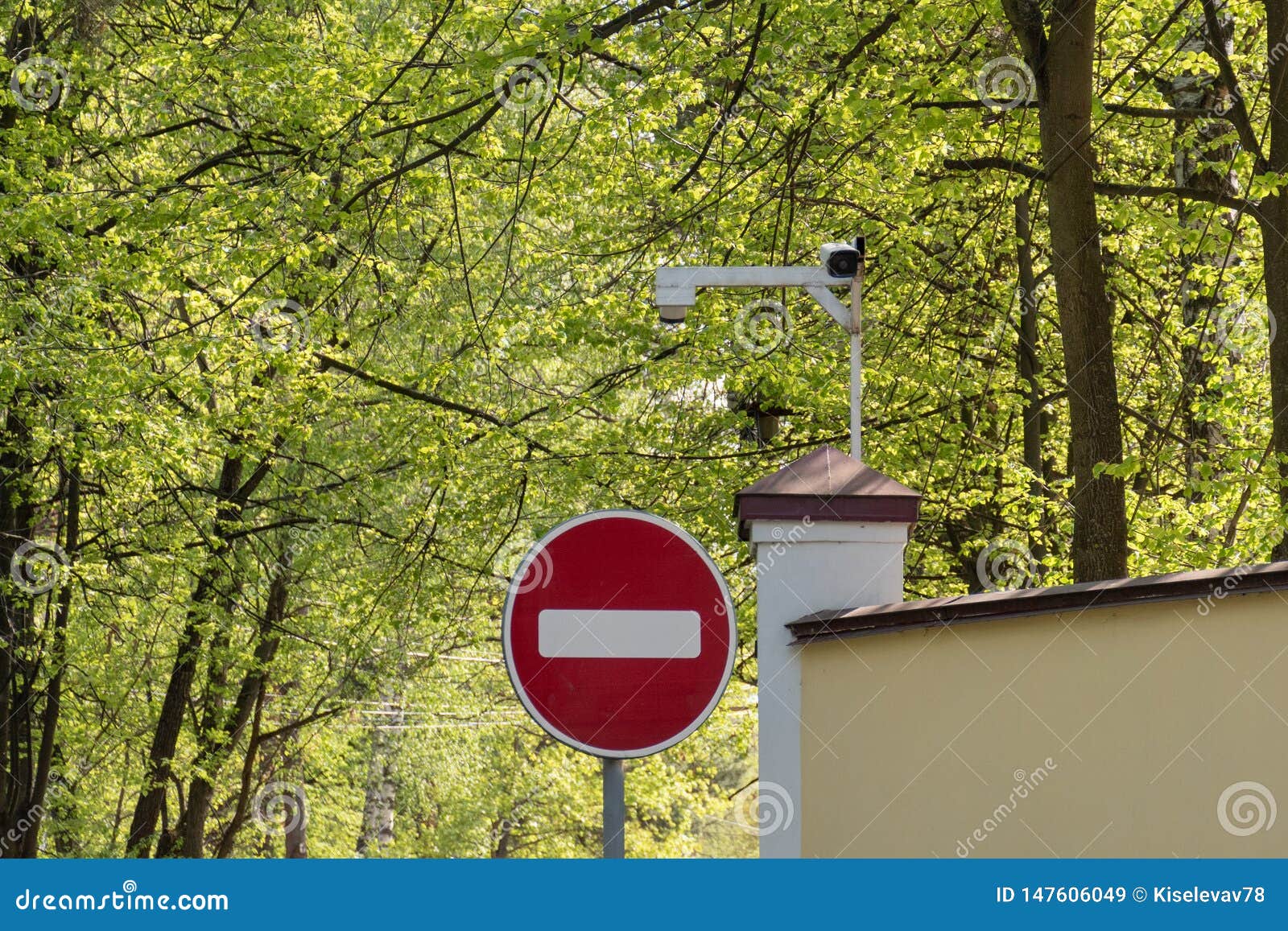 No Entry Road Sign and the Security Camera on the Background of Green ...