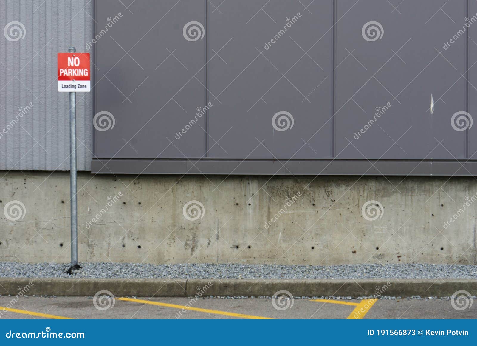 No Parking Loading Zone Against Metal and Cement Wall Stock Image ...