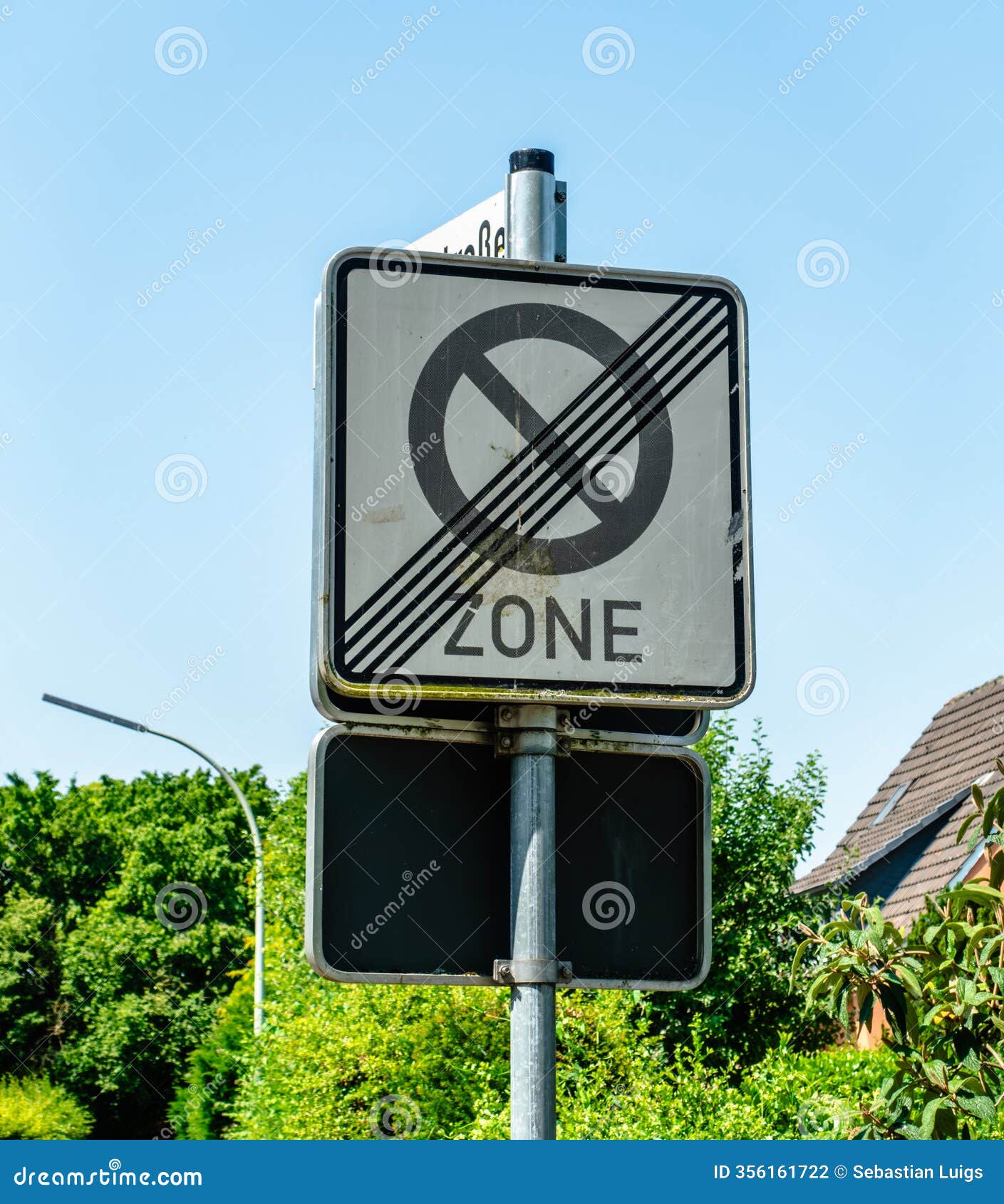 A No Zone Sign is on a Pole in Front of a House Stock Photo - Image of ...