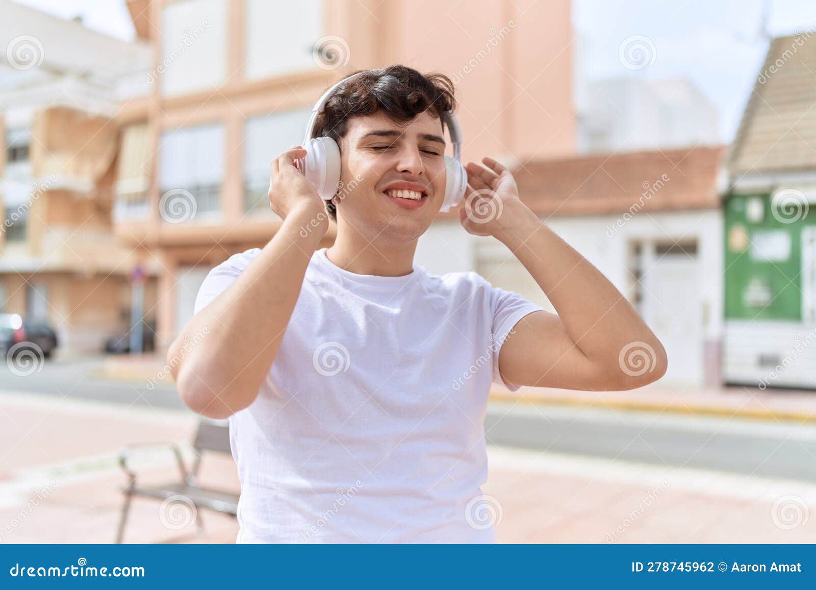 Non Binary Man Listening To Music Standing at Street Stock Photo ...