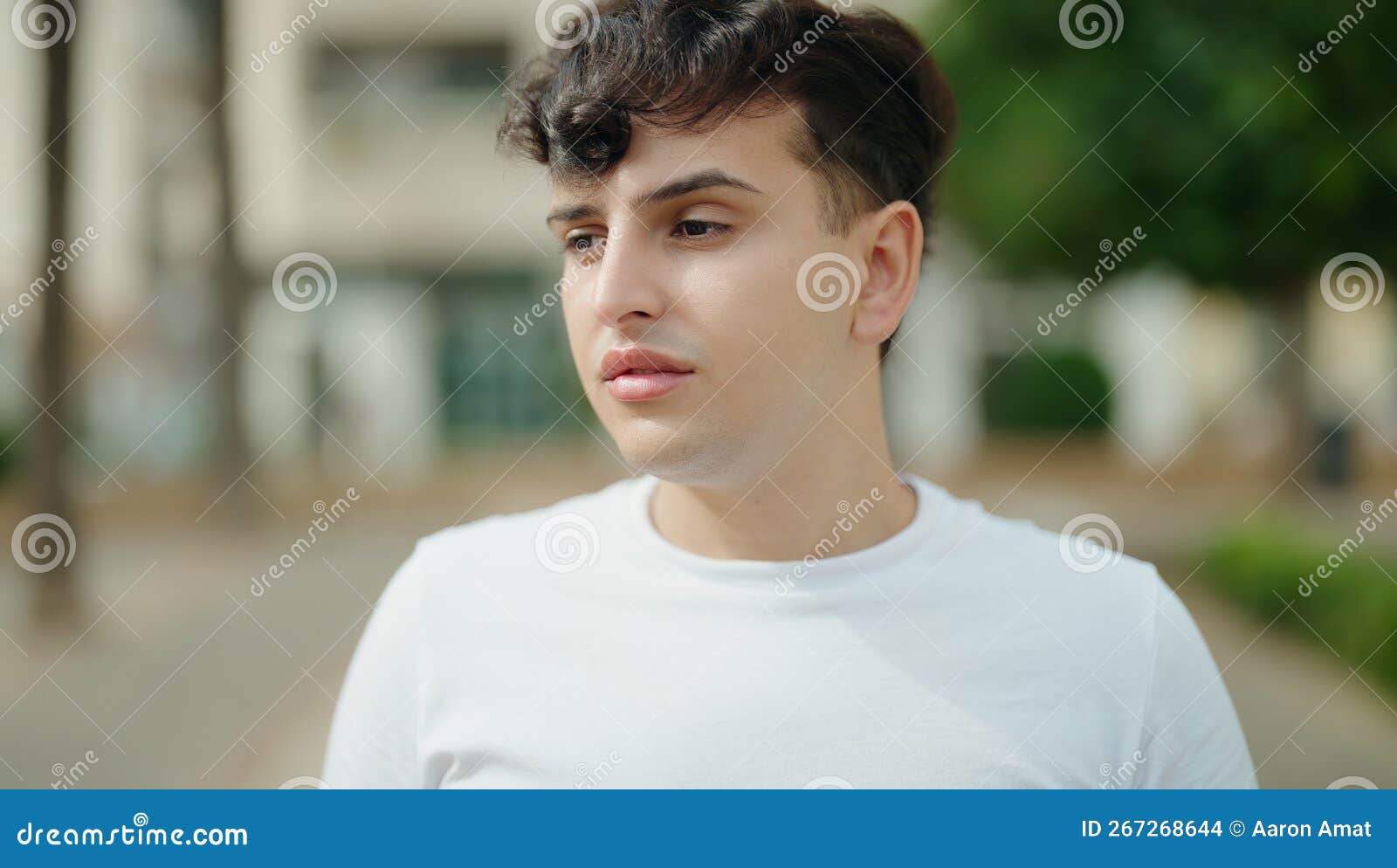 Non Binary Man Looking To the Side with Serious Expression at Park ...