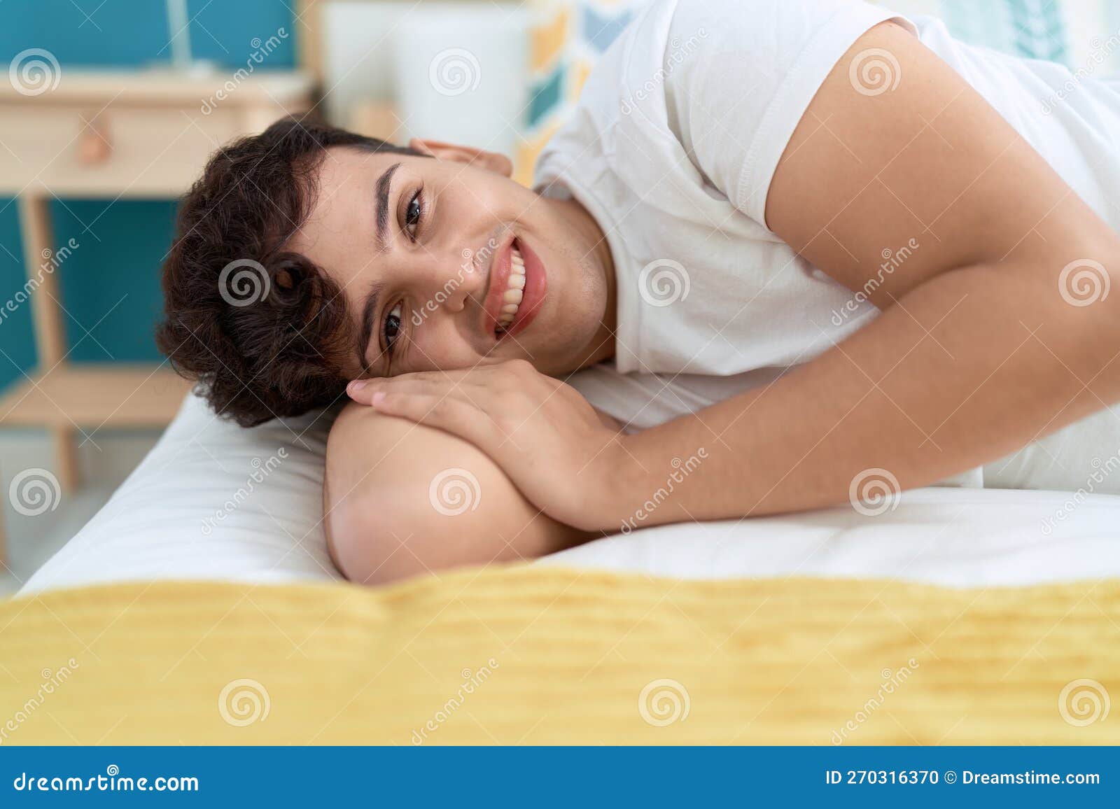 Non Binary Man Smiling Confident Lying on Bed at Bedroom Stock Photo ...