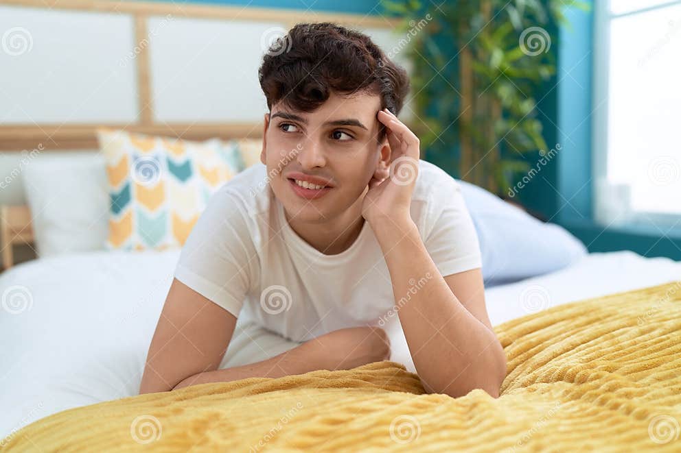 Non Binary Man Smiling Confident Lying on Bed at Bedroom Stock Photo - Image of relaxing ...