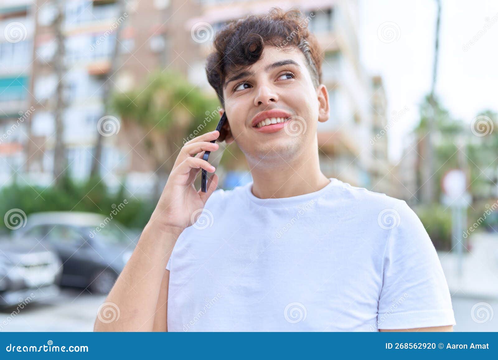 Non Binary Man Smiling Confident Talking on Smartphone at Street Stock ...