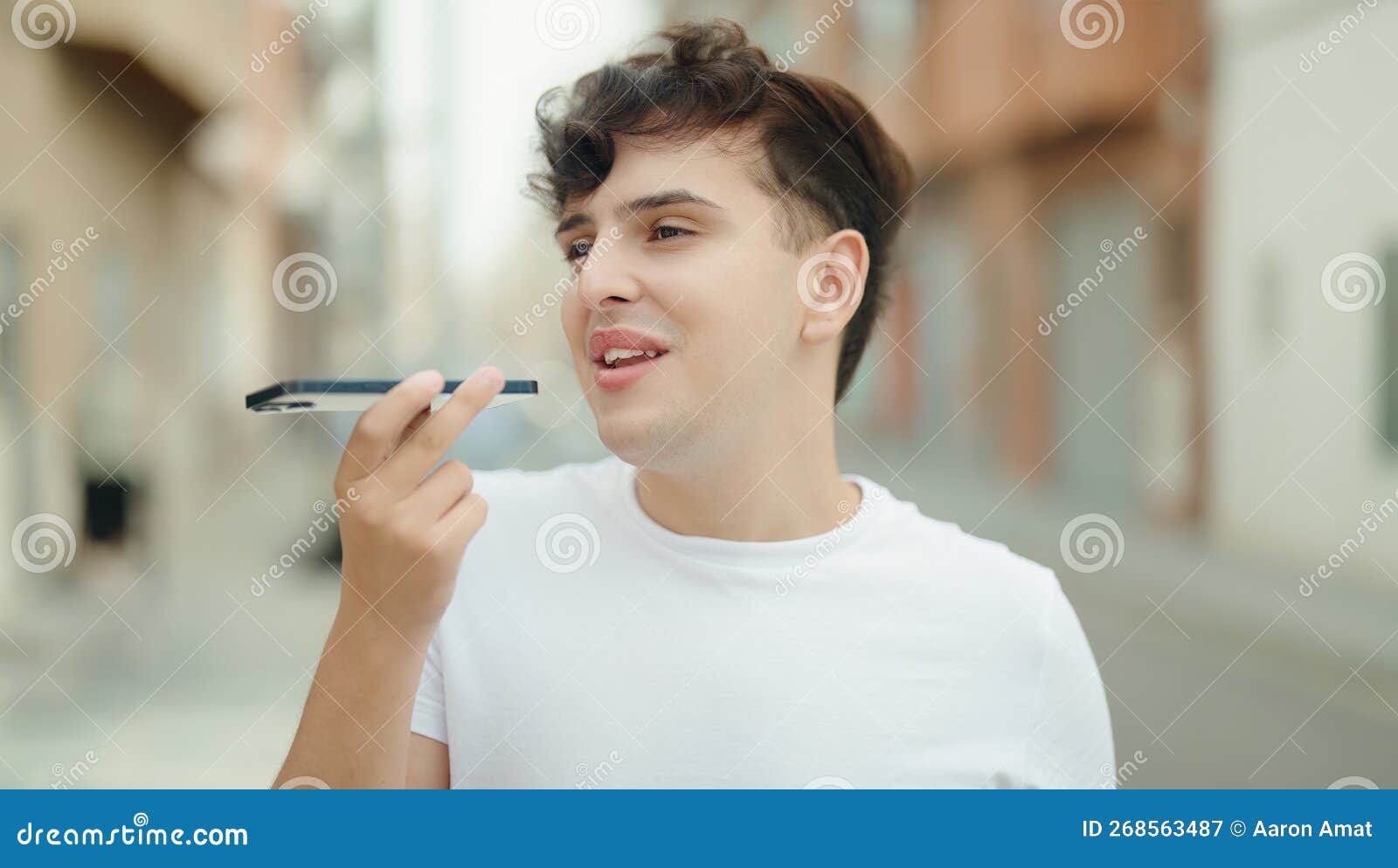 Non Binary Man Smiling Confident Talking on Smartphone at Street Stock ...