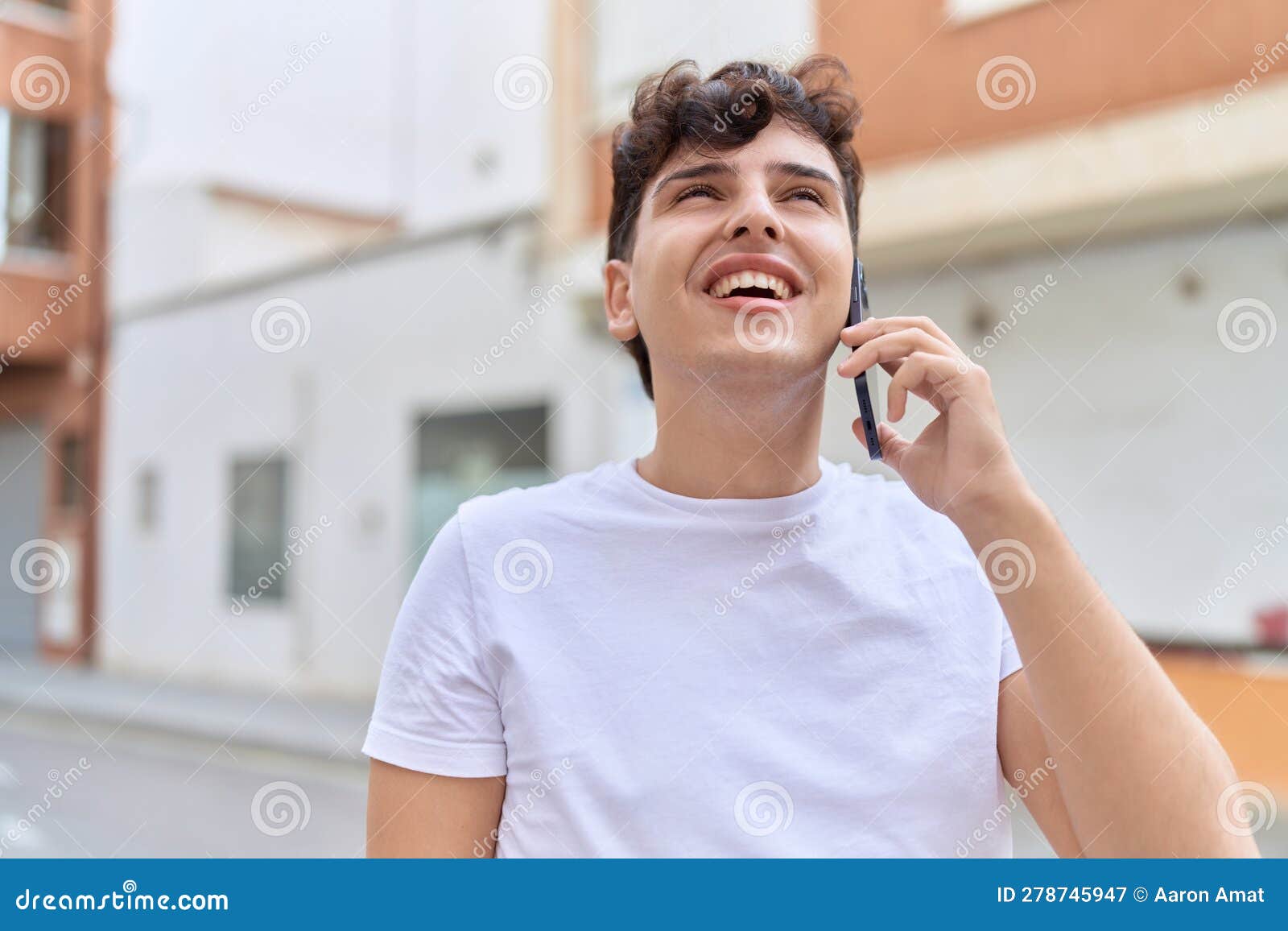 Non Binary Man Smiling Confident Talking on Smartphone at Street Stock ...