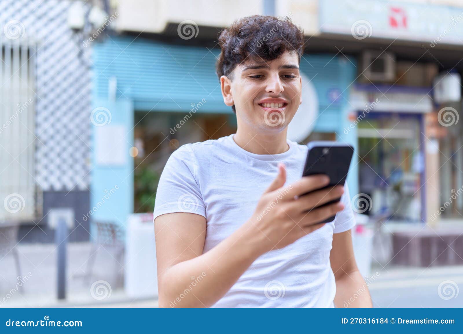 Non Binary Man Smiling Confident Using Smartphone at Street Stock Photo ...