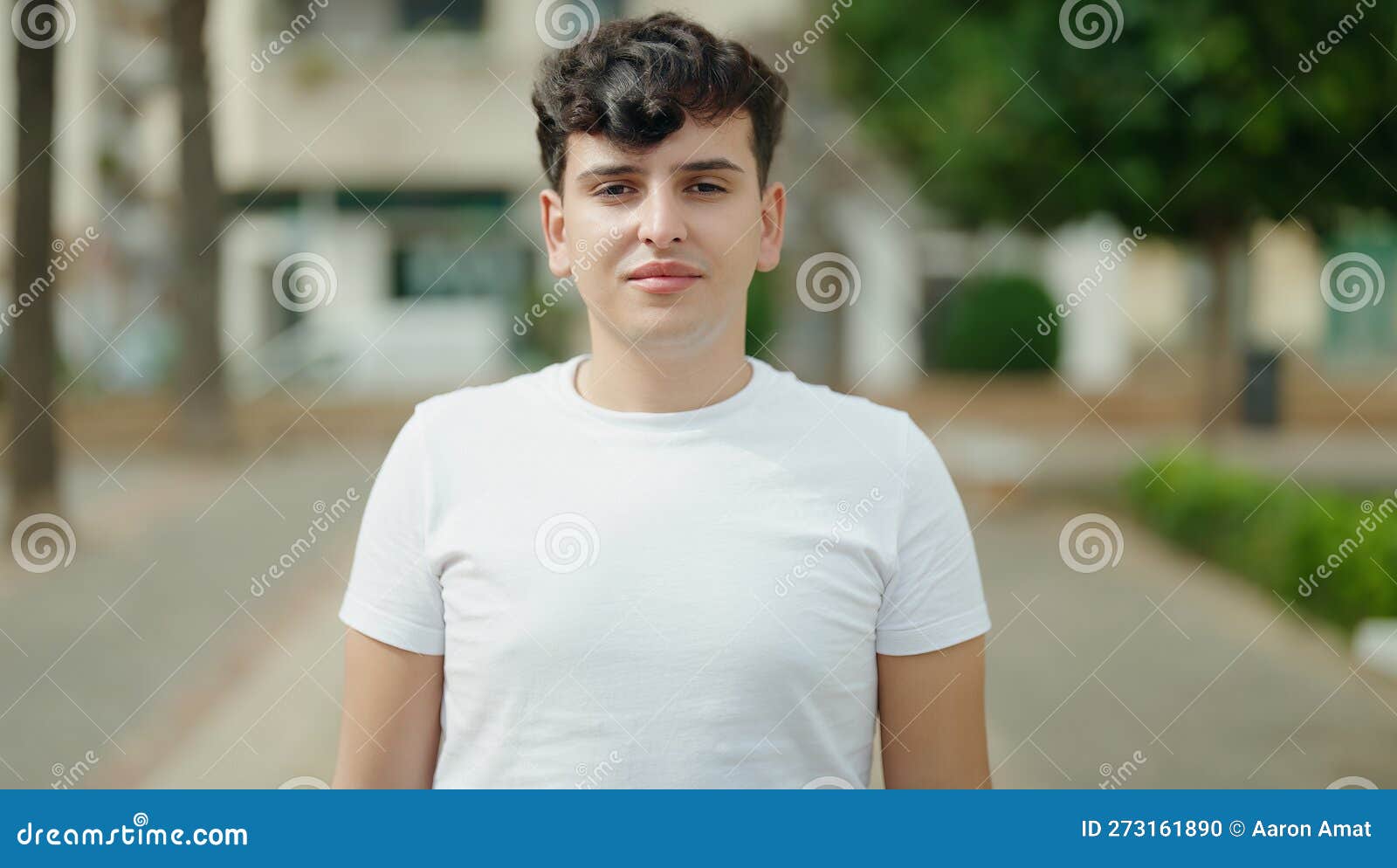 Non Binary Man Standing with Serious Expression at Park Stock Photo ...