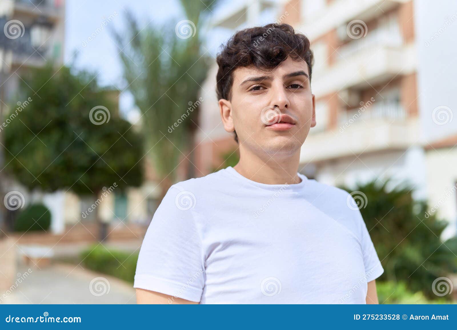 Non Binary Man Standing with Serious Expression at Park Stock Photo ...