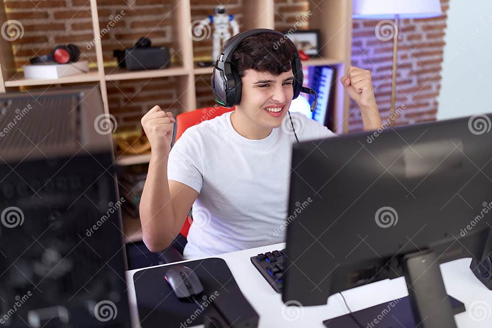 Non Binary Man Streamer Playing Video Game with Winner Expression at ...