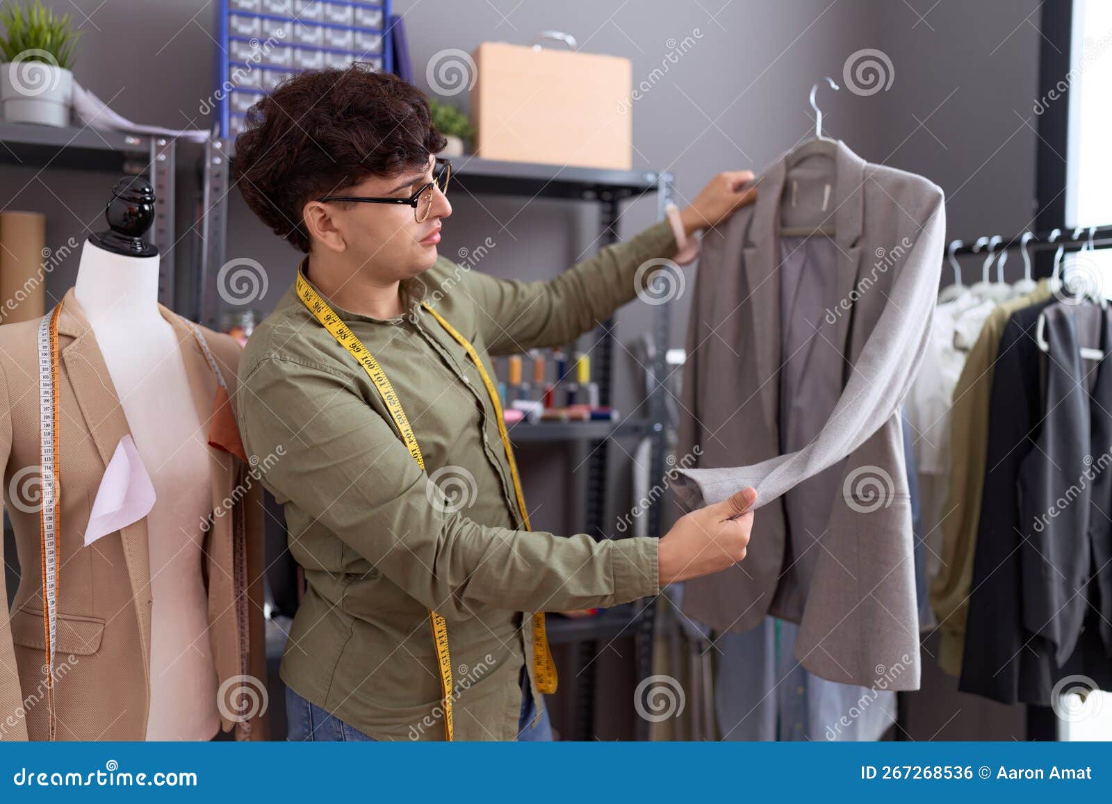 Non Binary Man Tailor Holding Jacket at Atelier Stock Photo - Image of ...
