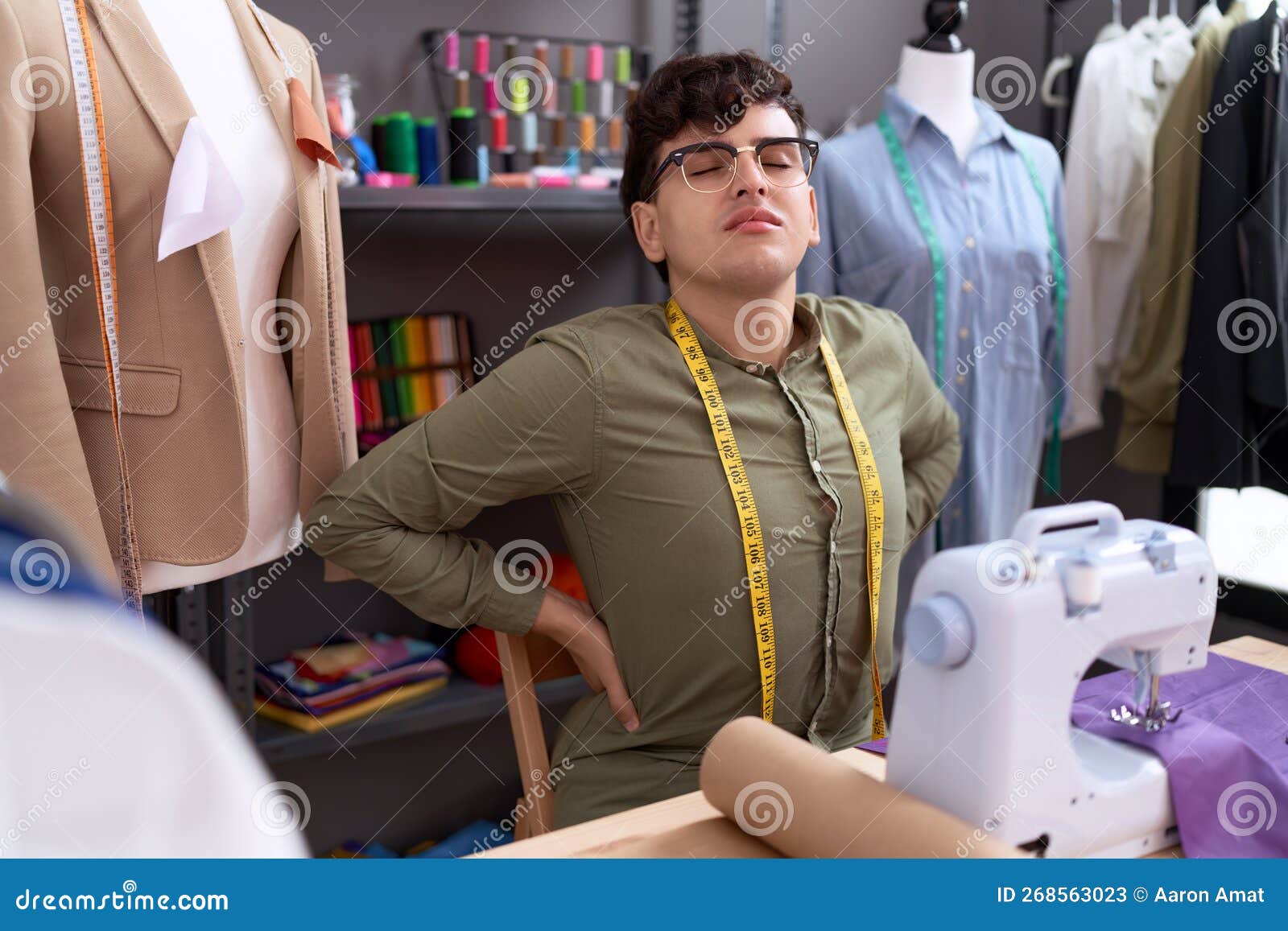 Non Binary Man Tailor Stressed Using Sewing Machine at Atelier Stock ... Non Binary Man Tailor Stressed Using Sewing Machine at Atelier Stock ...