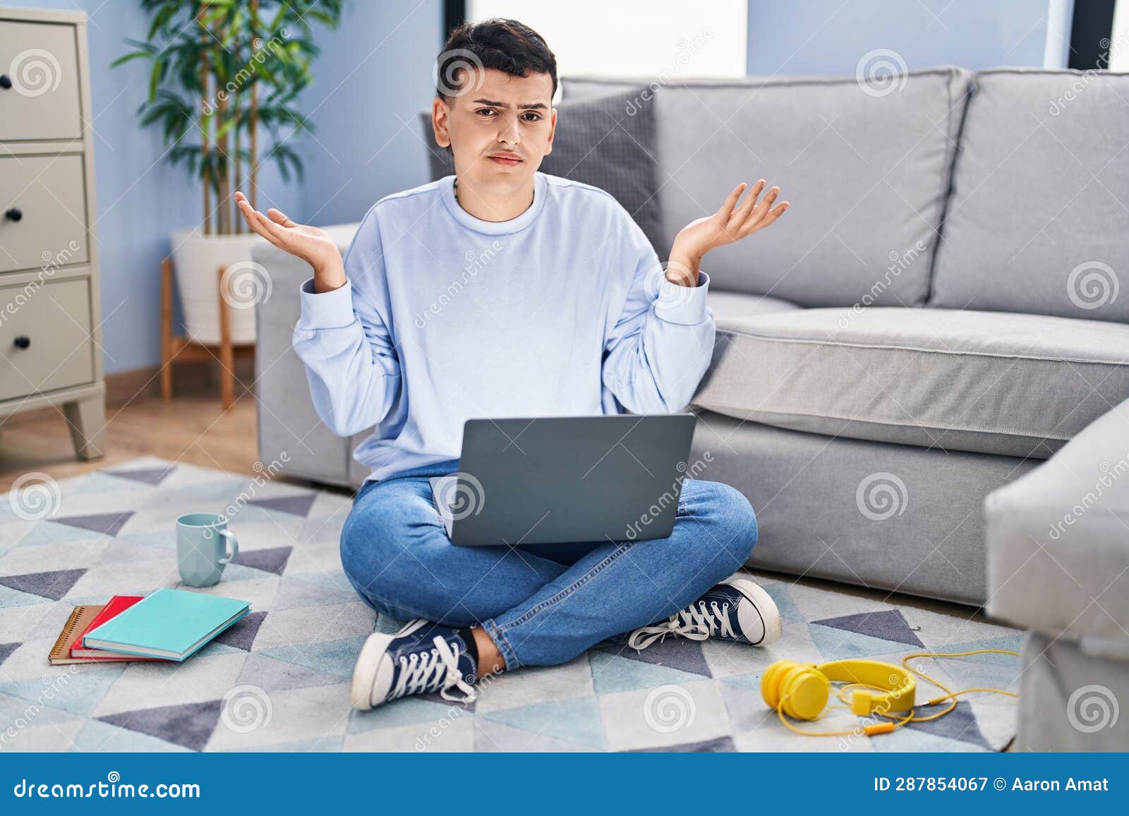 Non Binary Person Studying Using Computer Laptop Sitting on the Floor ...
