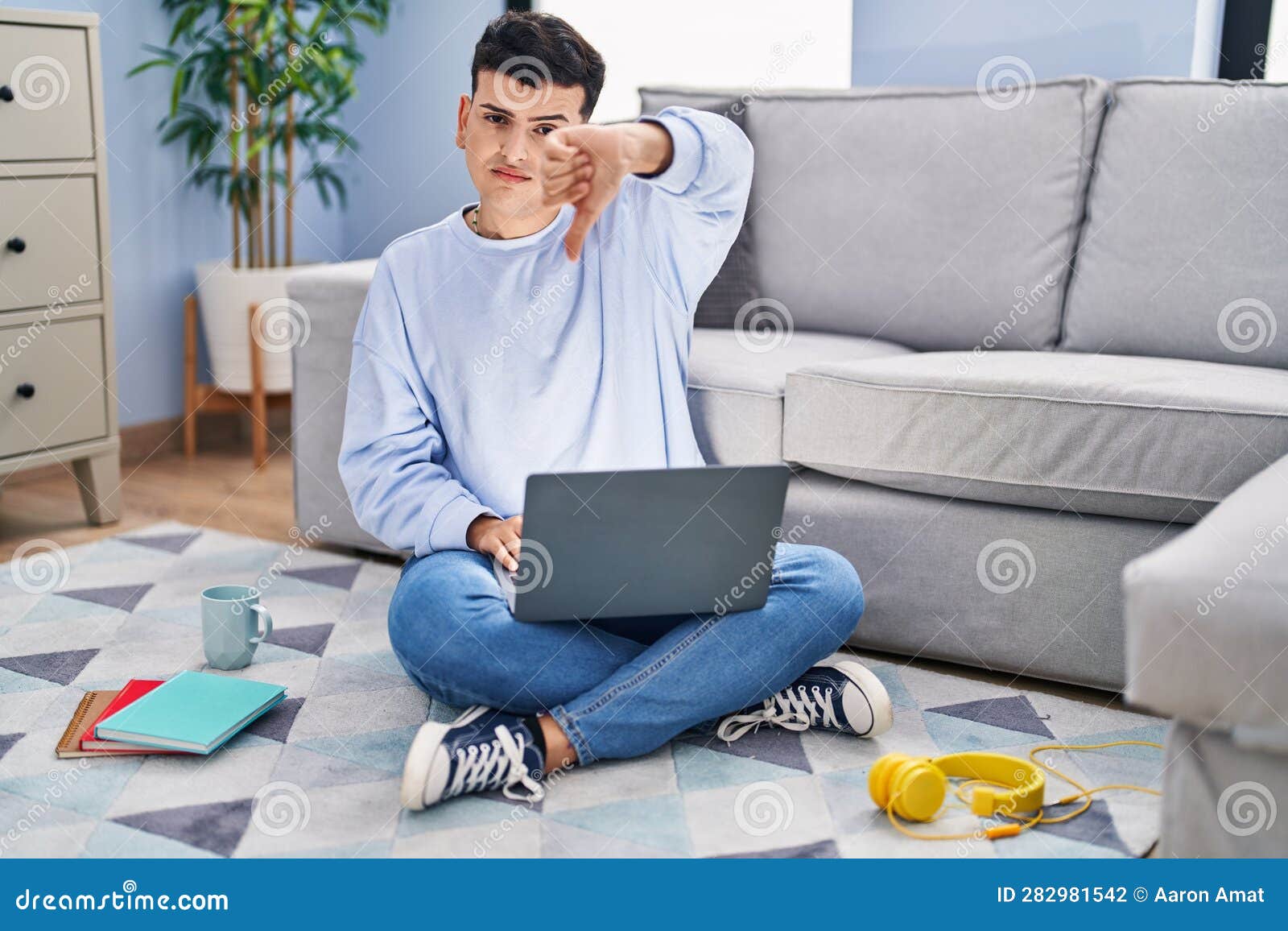Non Binary Person Studying Using Computer Laptop Sitting on the Floor ...