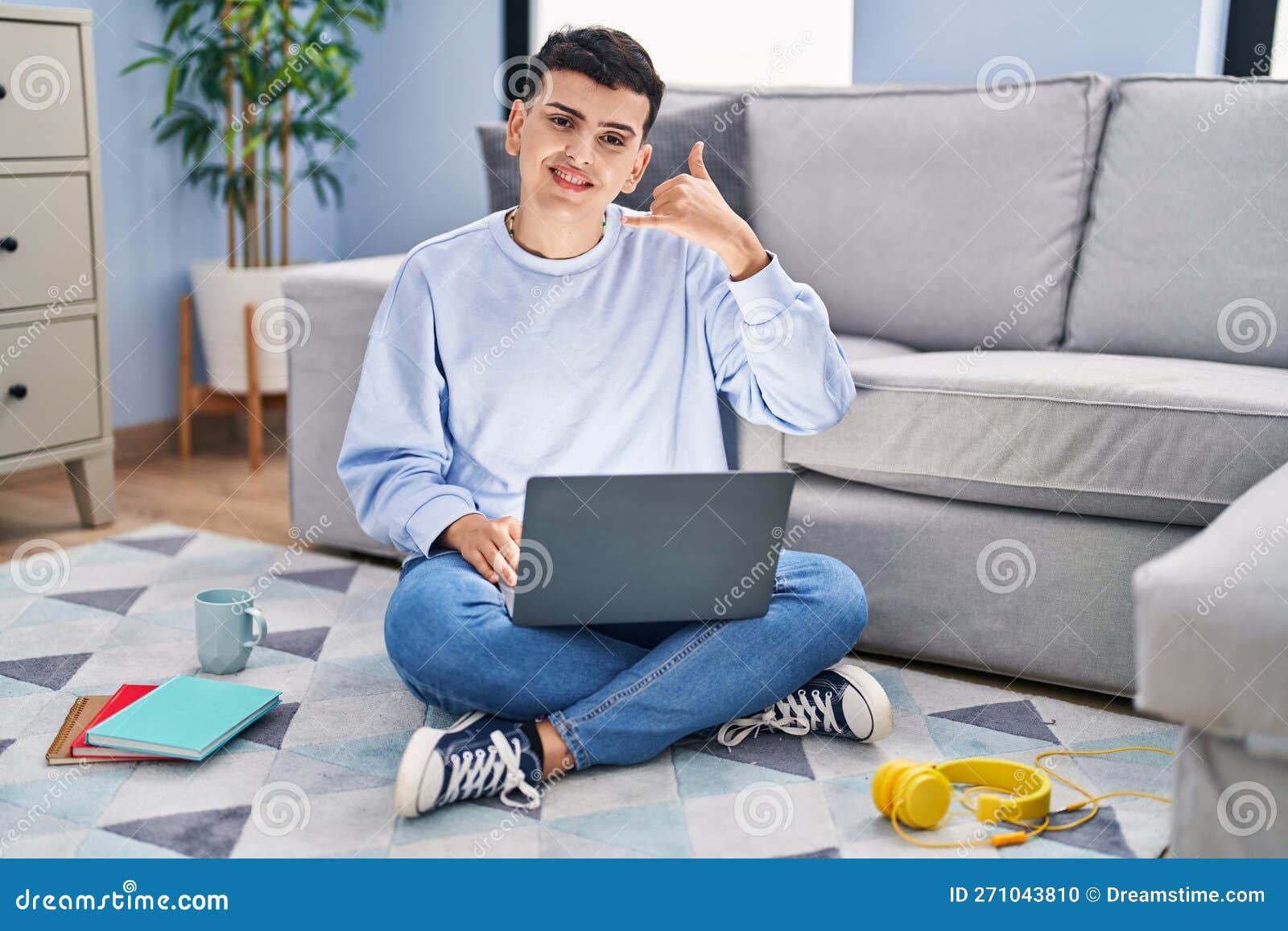 Non Binary Person Studying Using Computer Laptop Sitting on the Floor ...