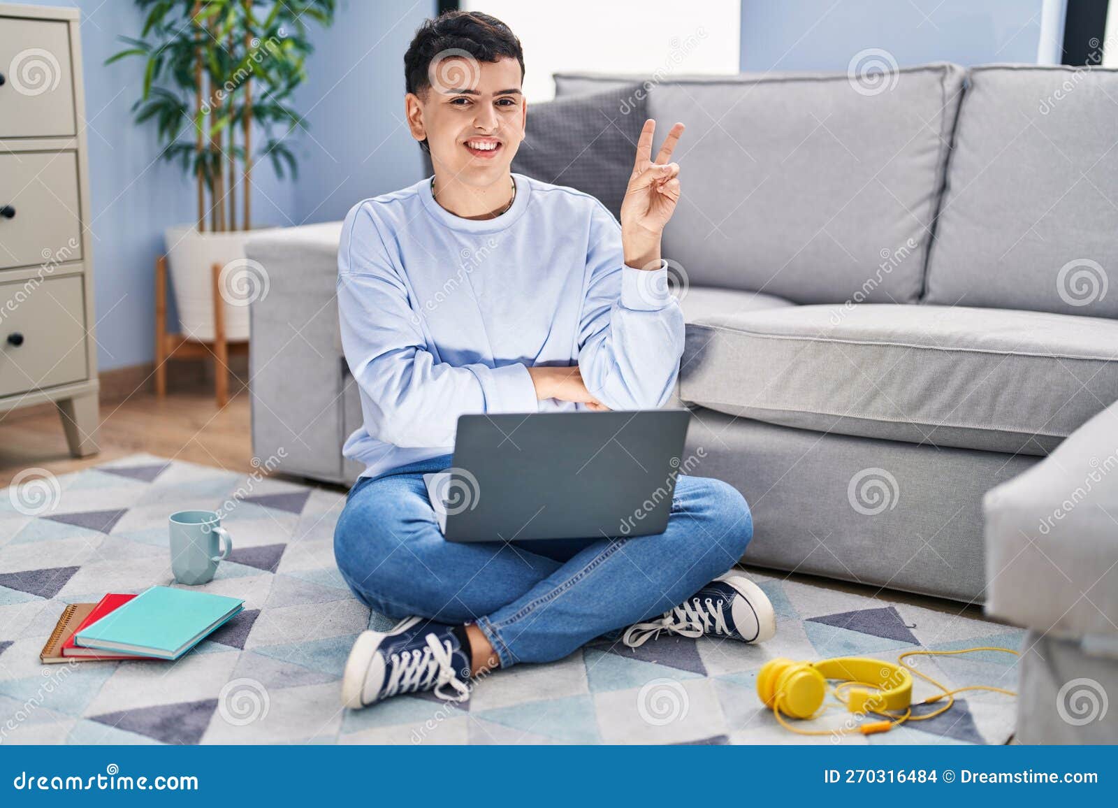 Non Binary Person Studying Using Computer Laptop Sitting on the Floor ...