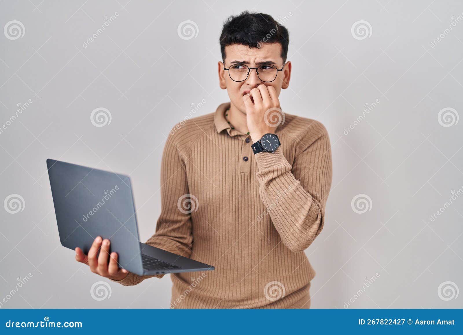 Non Binary Person Using Computer Laptop Looking Stressed and Nervous with Hands on Mouth Biting ...