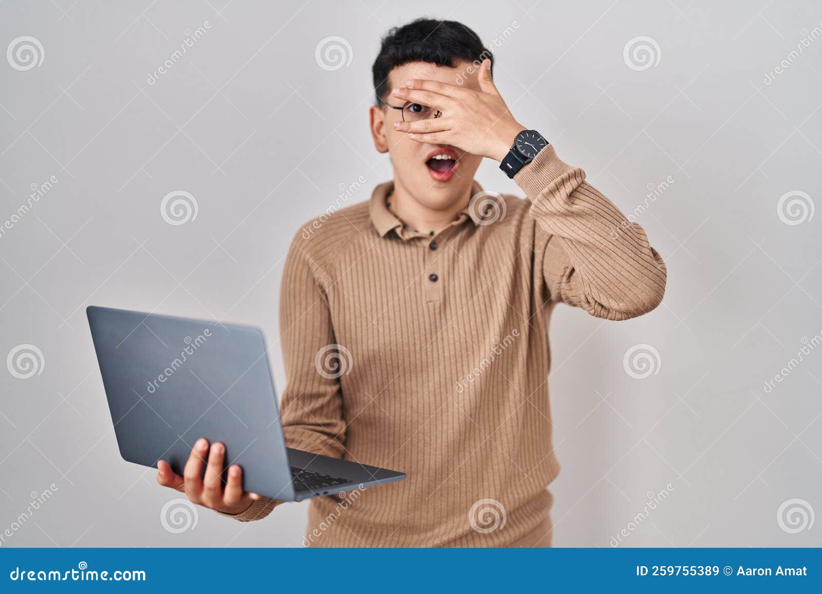 Non Binary Person Using Computer Laptop Peeking in Shock Covering Face ...