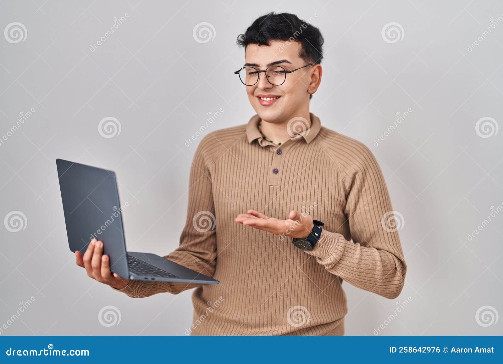 Non Binary Person Using Computer Laptop Pointing Aside with Hands Open ...