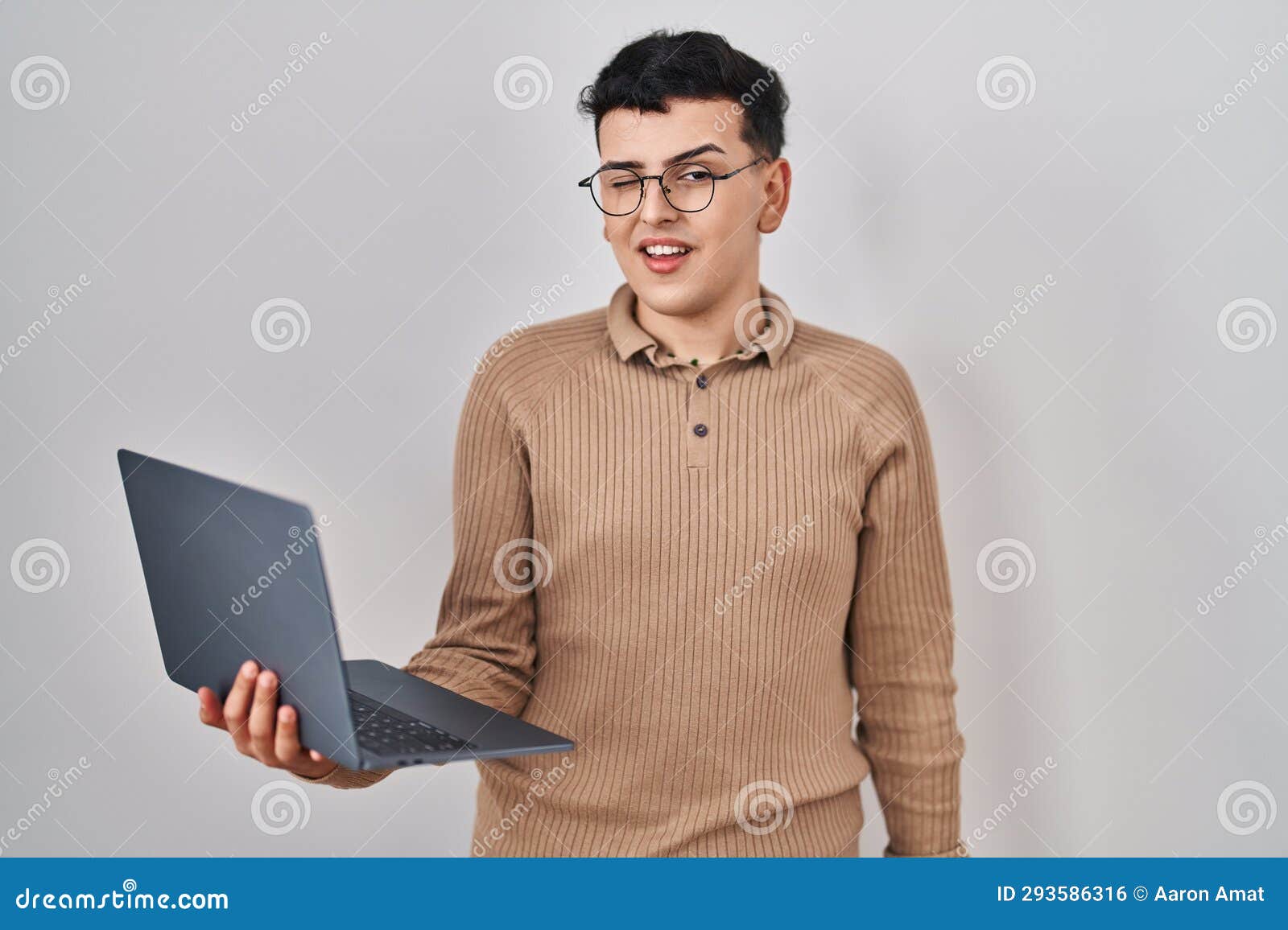Non Binary Person Using Computer Laptop Winking Looking at the Camera ...