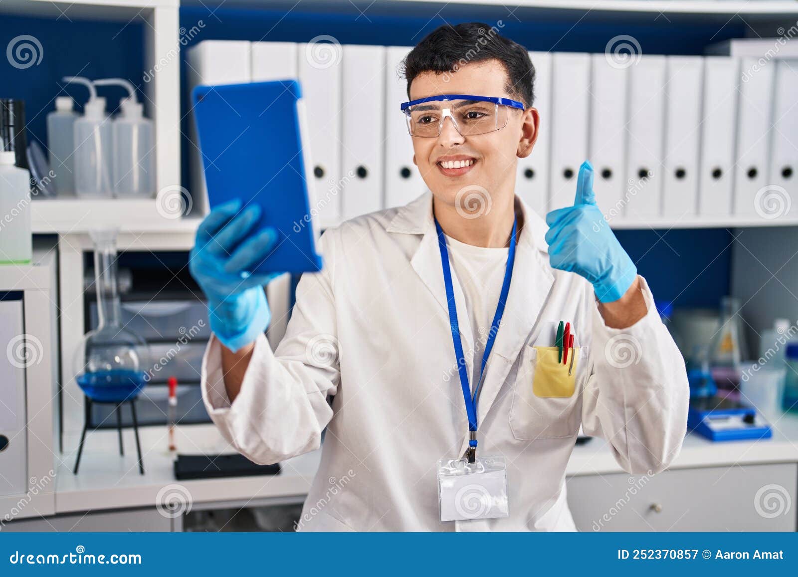Non Binary Person Working at Scientist Laboratory Using Tablet Smiling ...