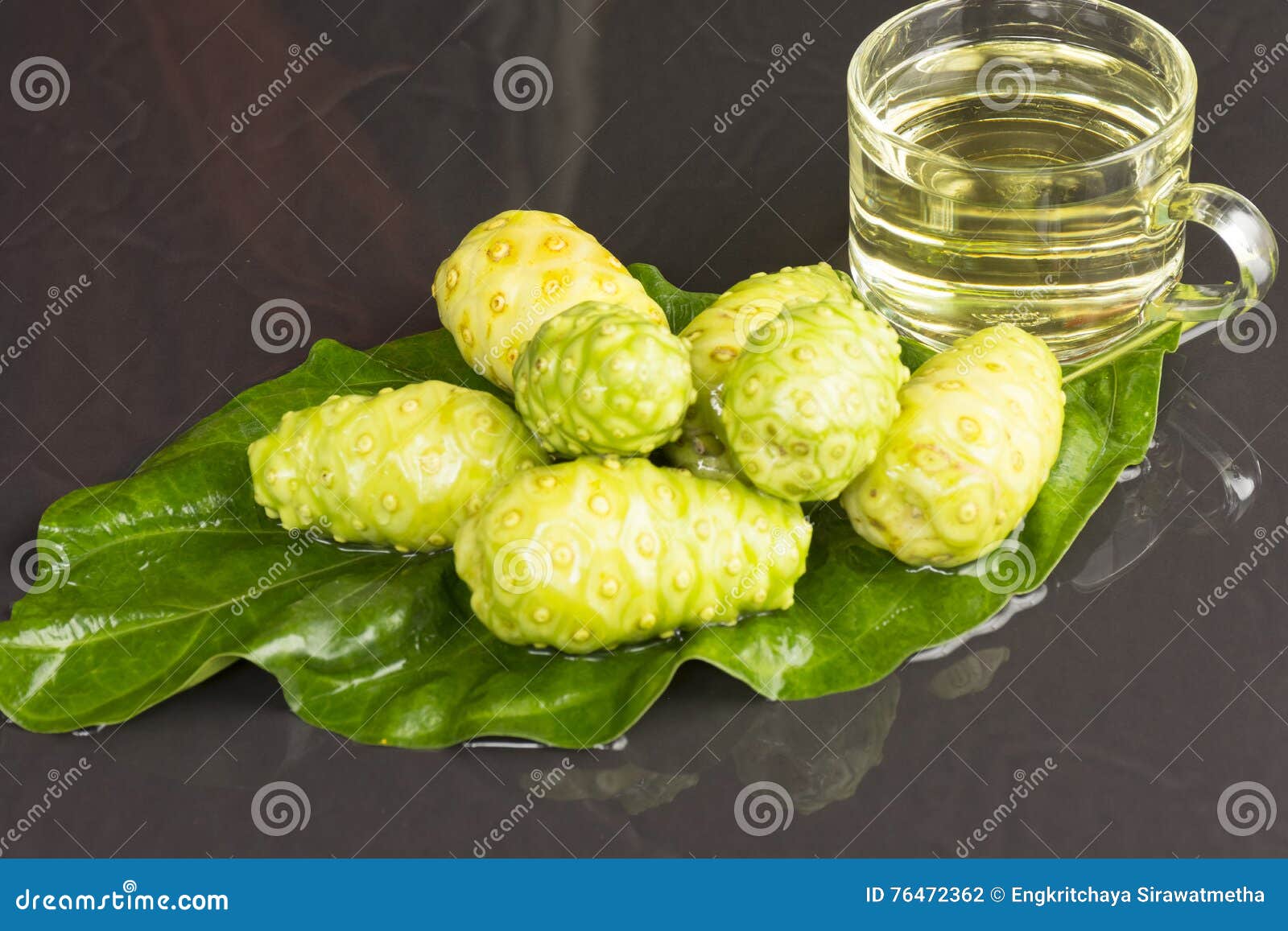 Noni Fruit and Noni Juice on Black Table.Fruit for Health and Herb ...