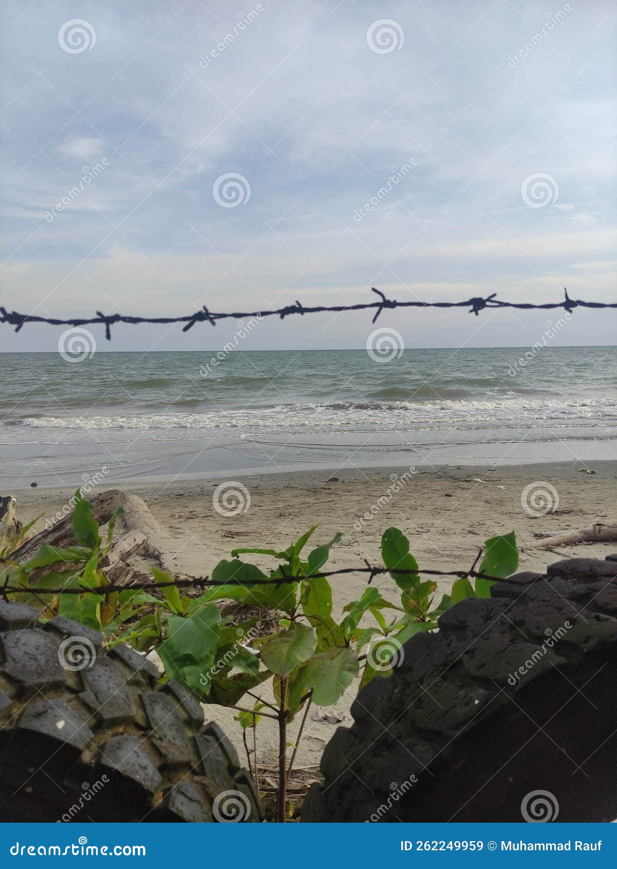 Noon at the Beach with Small Waves Behind a Barbed Wire Stock Image ...