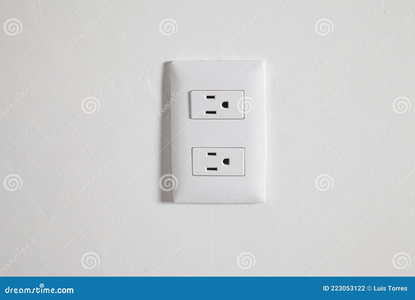 North American Power Outlet Plug in Socket on a White Wall Background ...