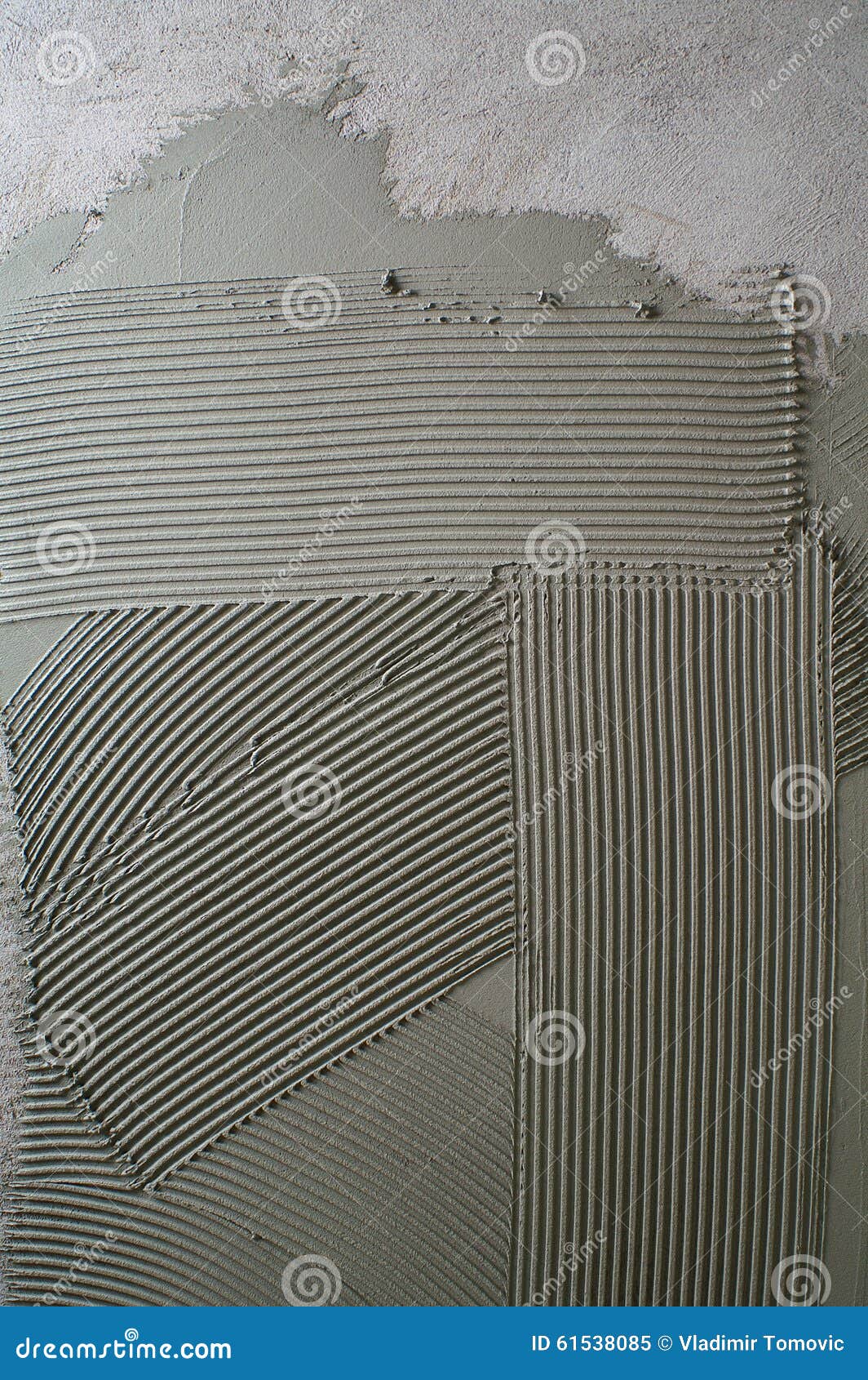 Notched Troweling Mortar Onto a Concrete Wall in Preparation Stock ...