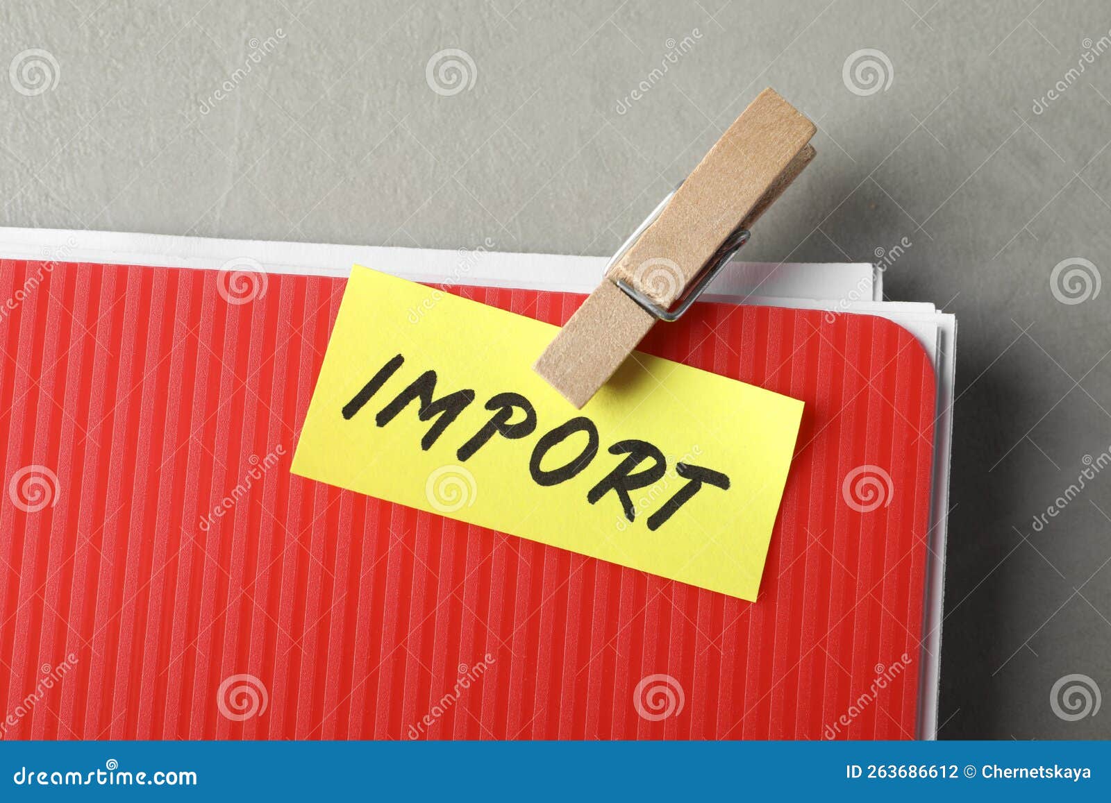 Note with Word Import Attached To Folder of Documents on Grey Table ...