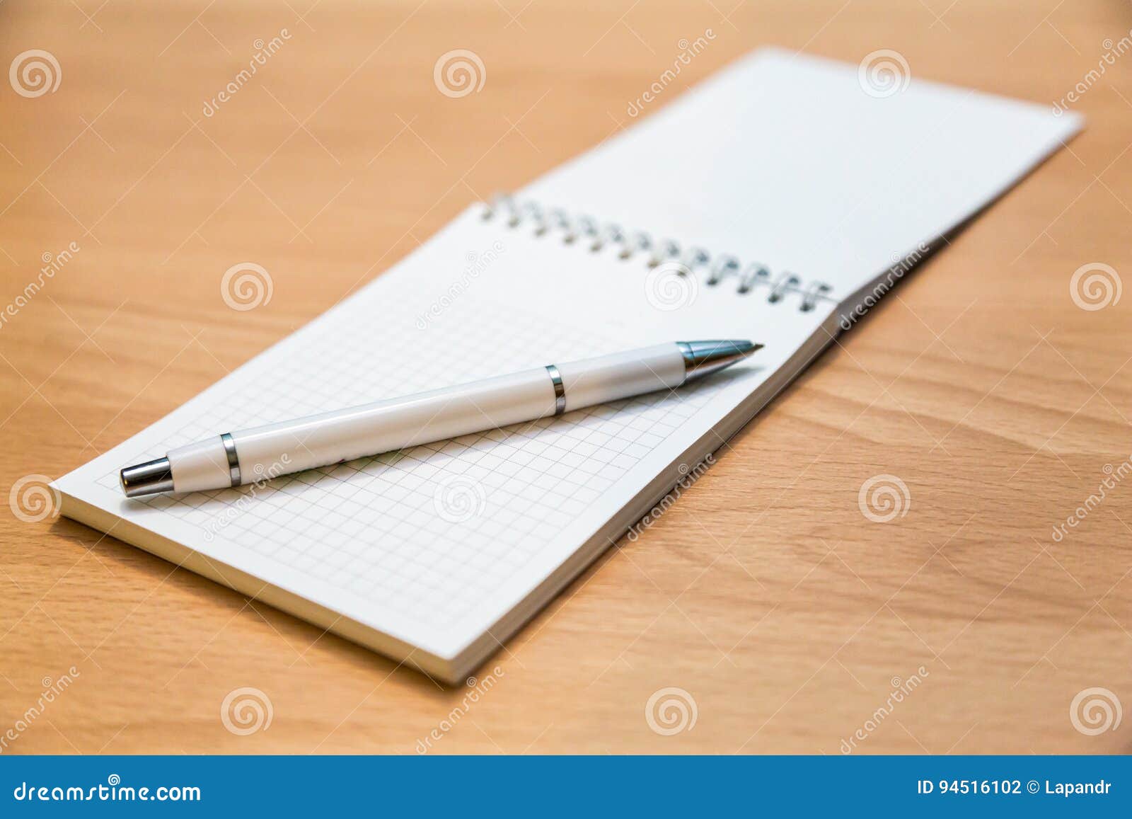 A Notebook and Ballpoint Pen Lying on a Wooden Table Stock Photo ...