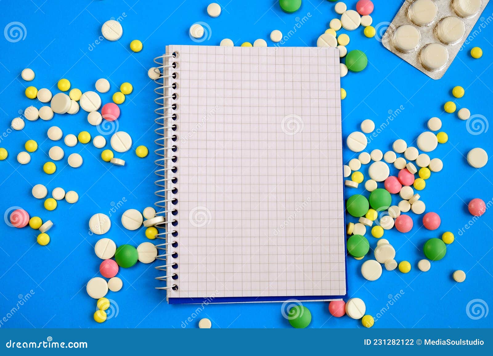Notebook on a Blue Background and Many Different Pills Stock Photo ...