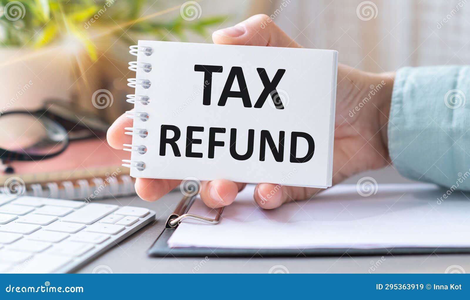 Notebook with a Business Notes TAX REFUND on the Office Table with ...