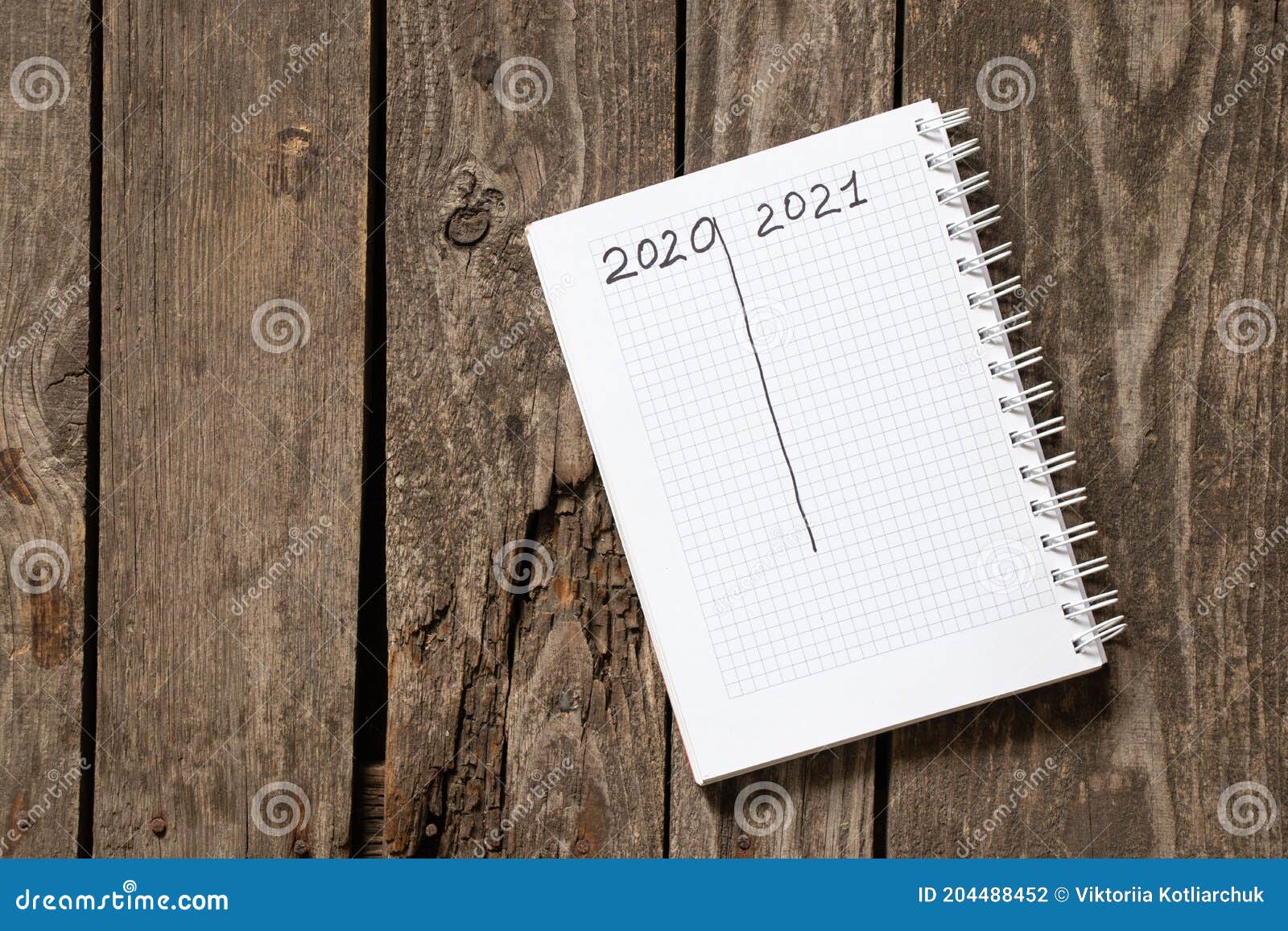 The Notebook is Divided into Two Columns 2020 and 2021 on a Wooden ...