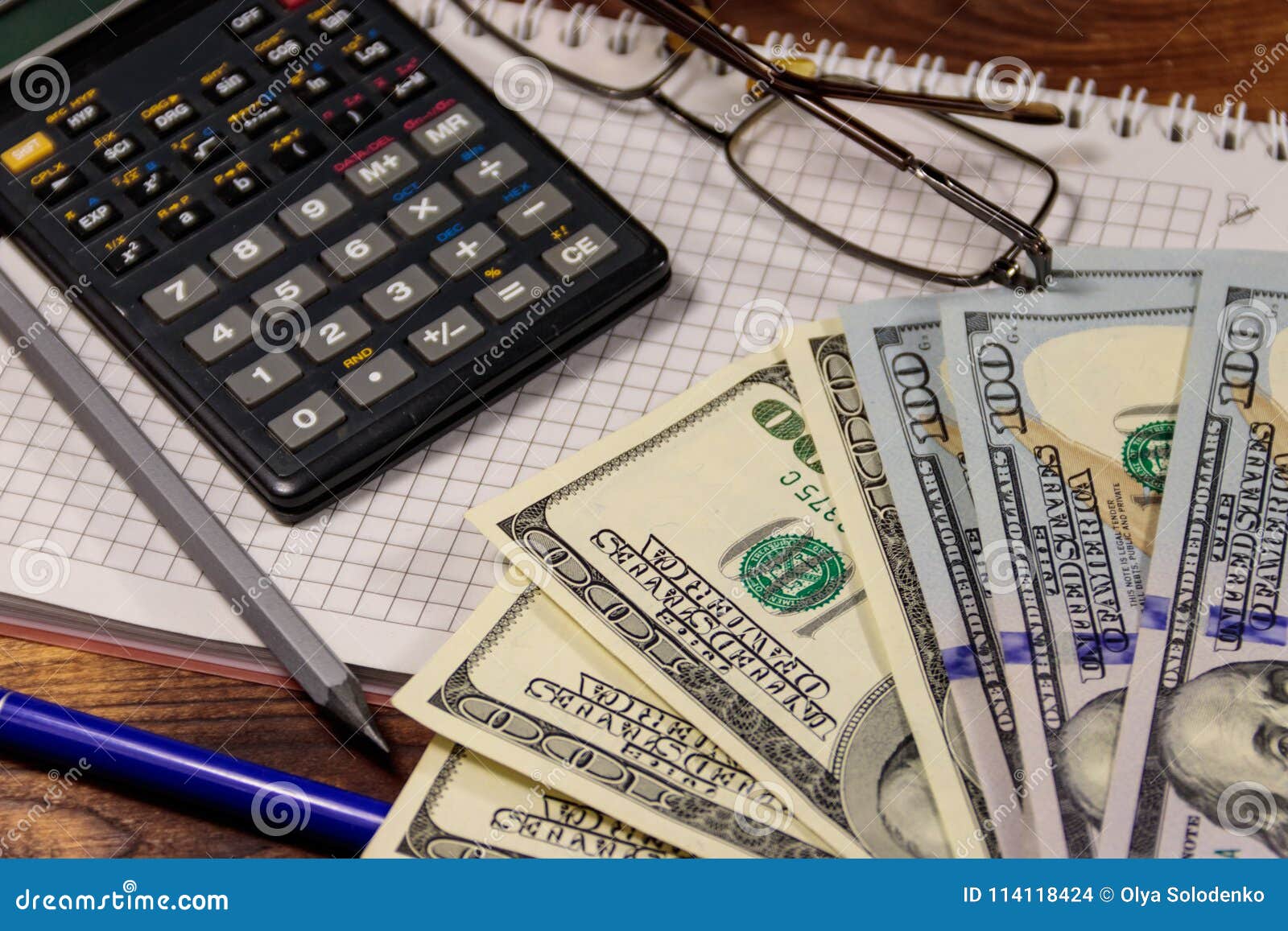 Notebook with Dollars, Pen, Glasses and Calculator on Wooden Desk Stock ... Notebook with Dollars, Pen, Glasses and Calculator on Wooden Desk Stock ...