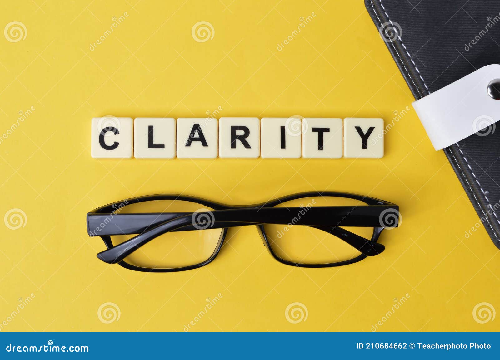 Top View of Eyeglasses, Notebook and Square Letters with Text CLARITY ...