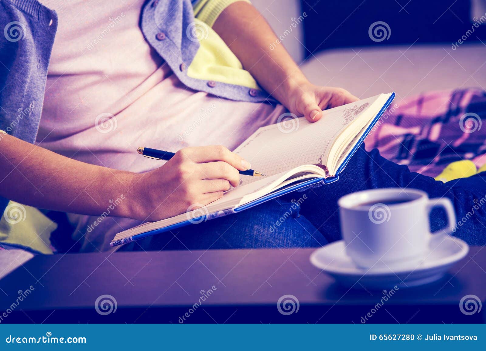 Notebook in hand stock photo. Image of home, sofa, background - 65627280