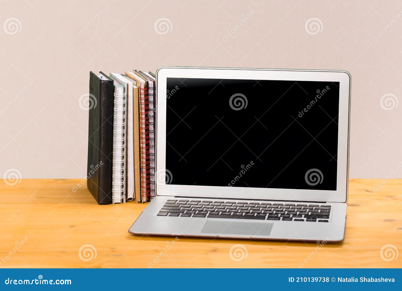 Notebook with Multi-colored Books on a Wooden Table. Mocap. Work from ...